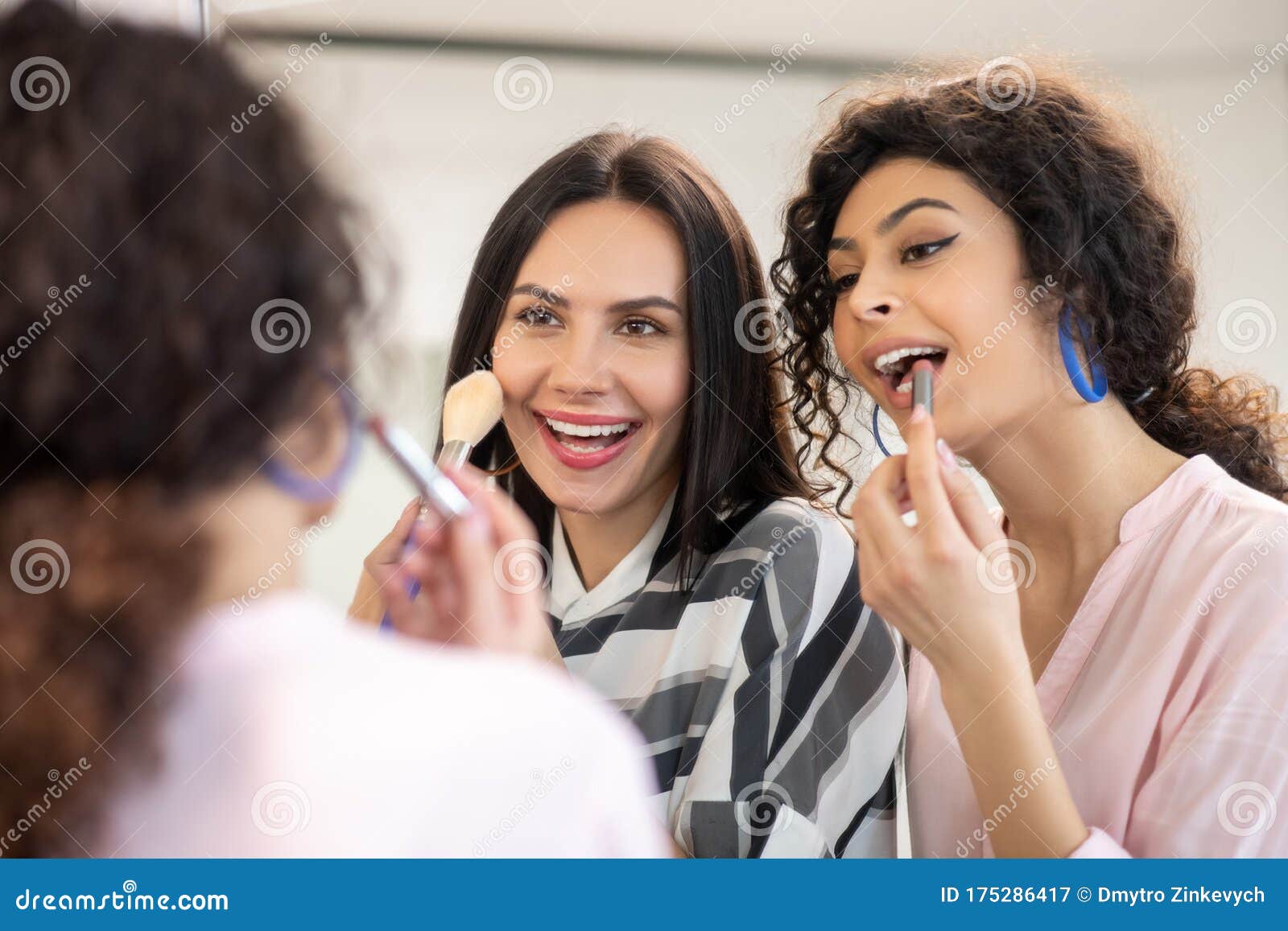 Two Dark-haired Women Doing Make Up and Feeling Amused Stock Image ...