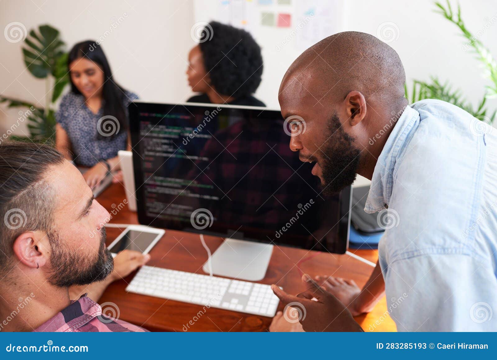 Two Developers Peer Programming Together in Office, Assisting Peer ...