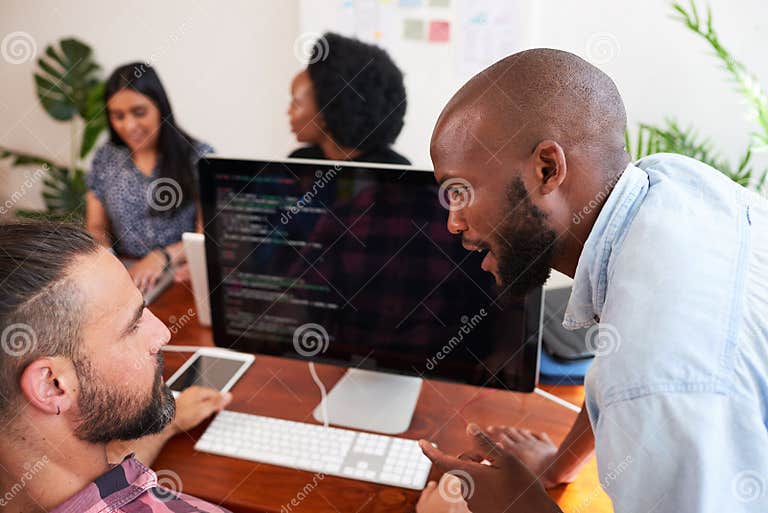 Two Developers Peer Programming Together in Office, Assisting Peer ...