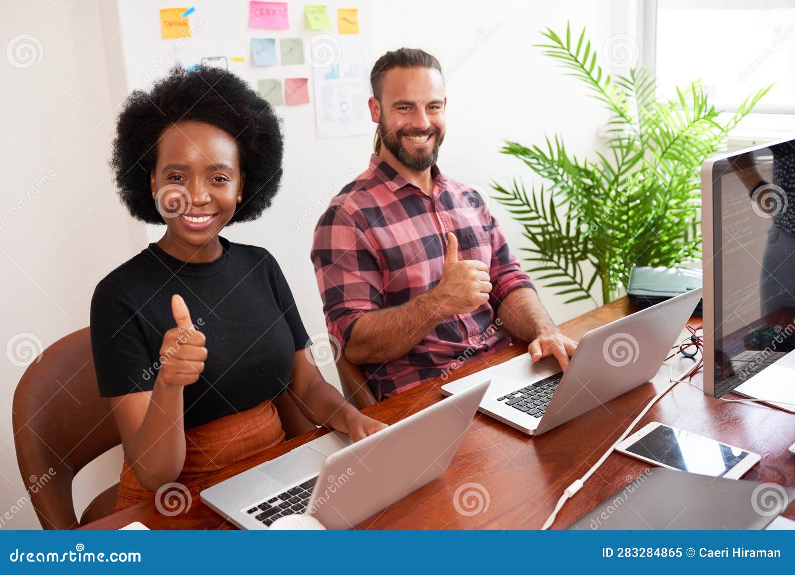 Two Developers Sitting at Shared Desk Give Thumbs Up, Coding in Office ...