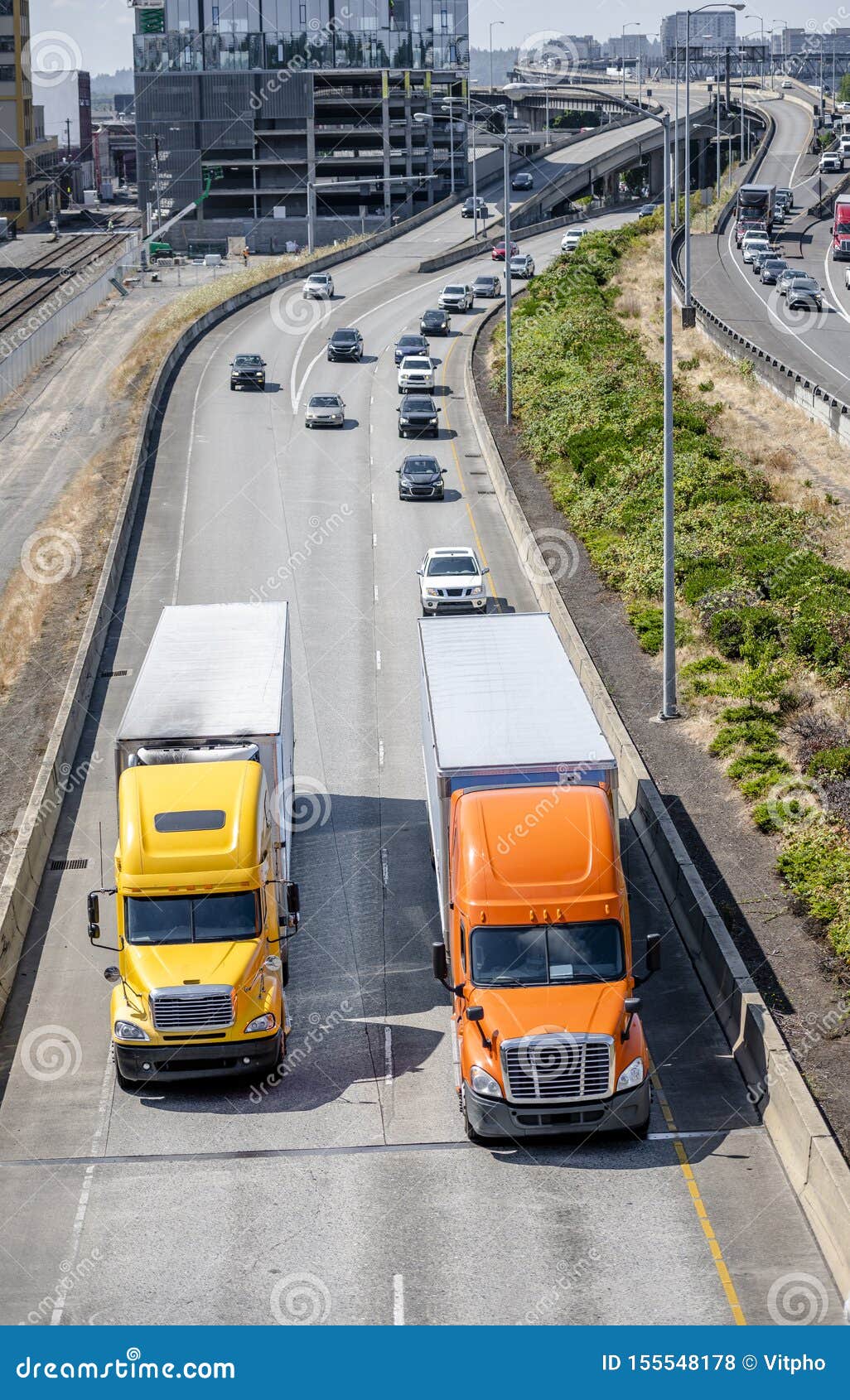 Two Different Big Rig Semi Trucks with Semi Trailers Running in Front ...
