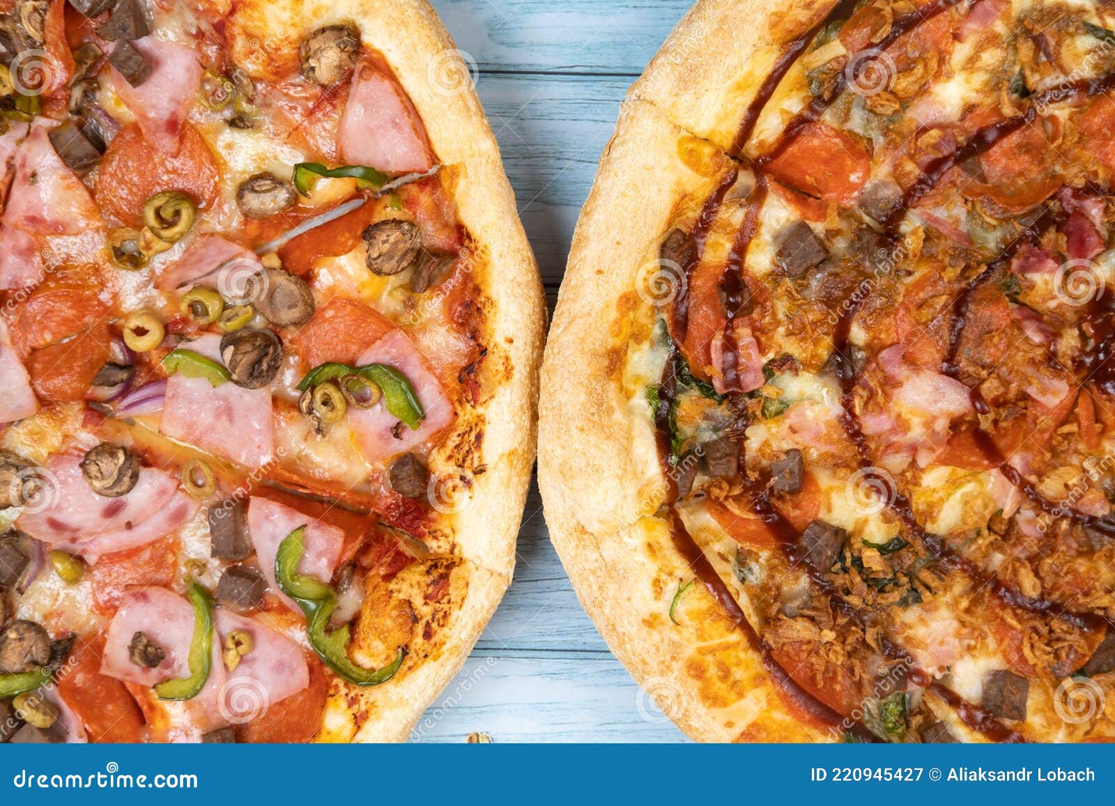 Two Different Delicious Big Pizzas on a Blue Wooden Background Stock ...