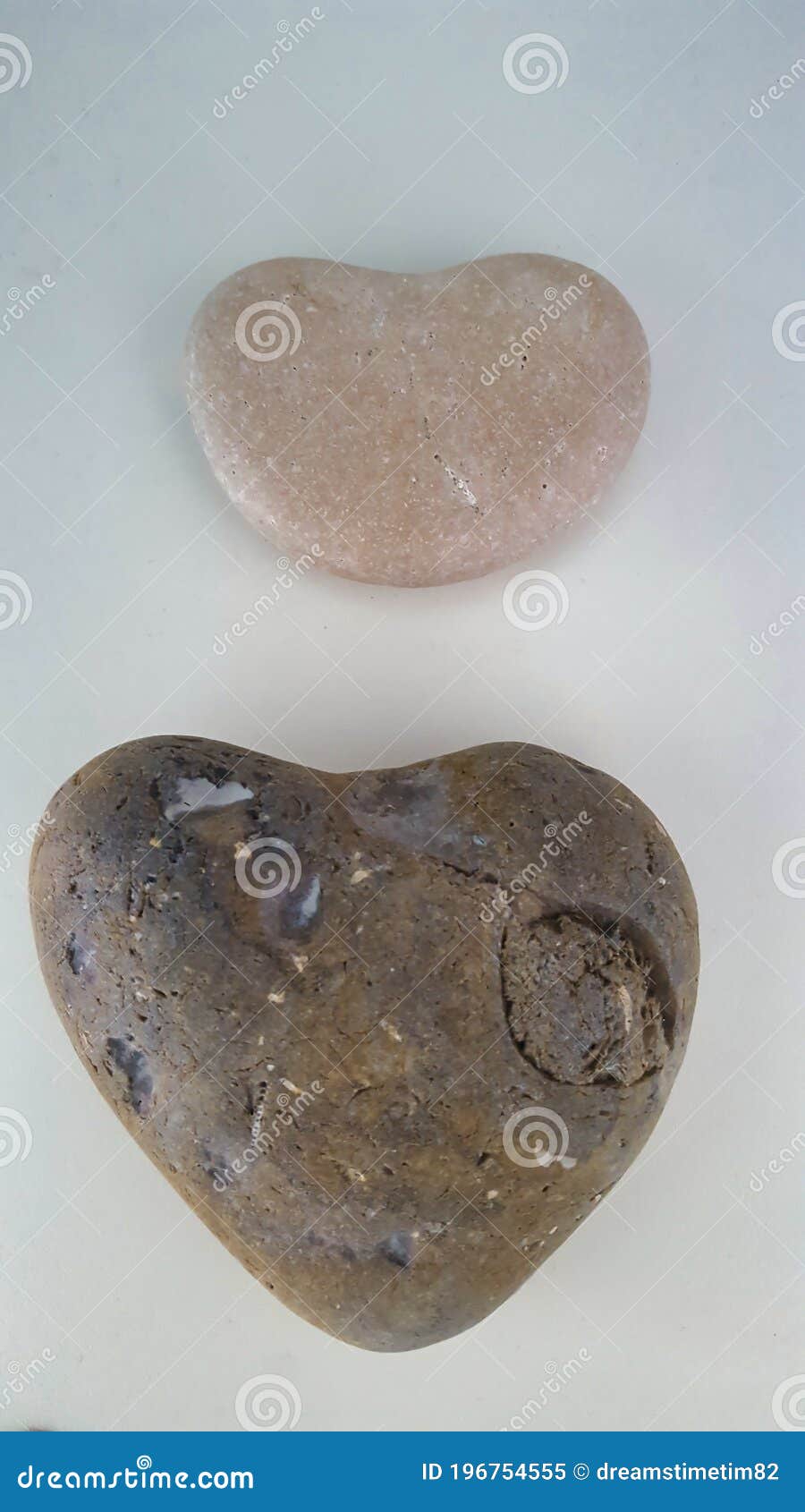 Two Different Hearts Made from Stone with a White Background Stock ...