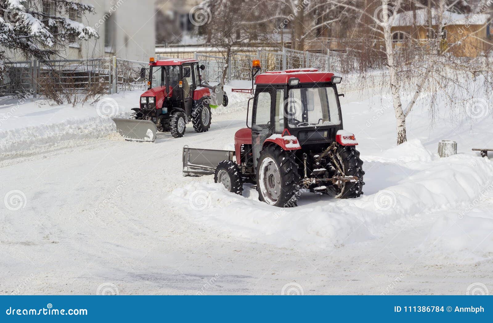 Two Different Small Red Tractor Snow Plows during Work Stock Photo ...