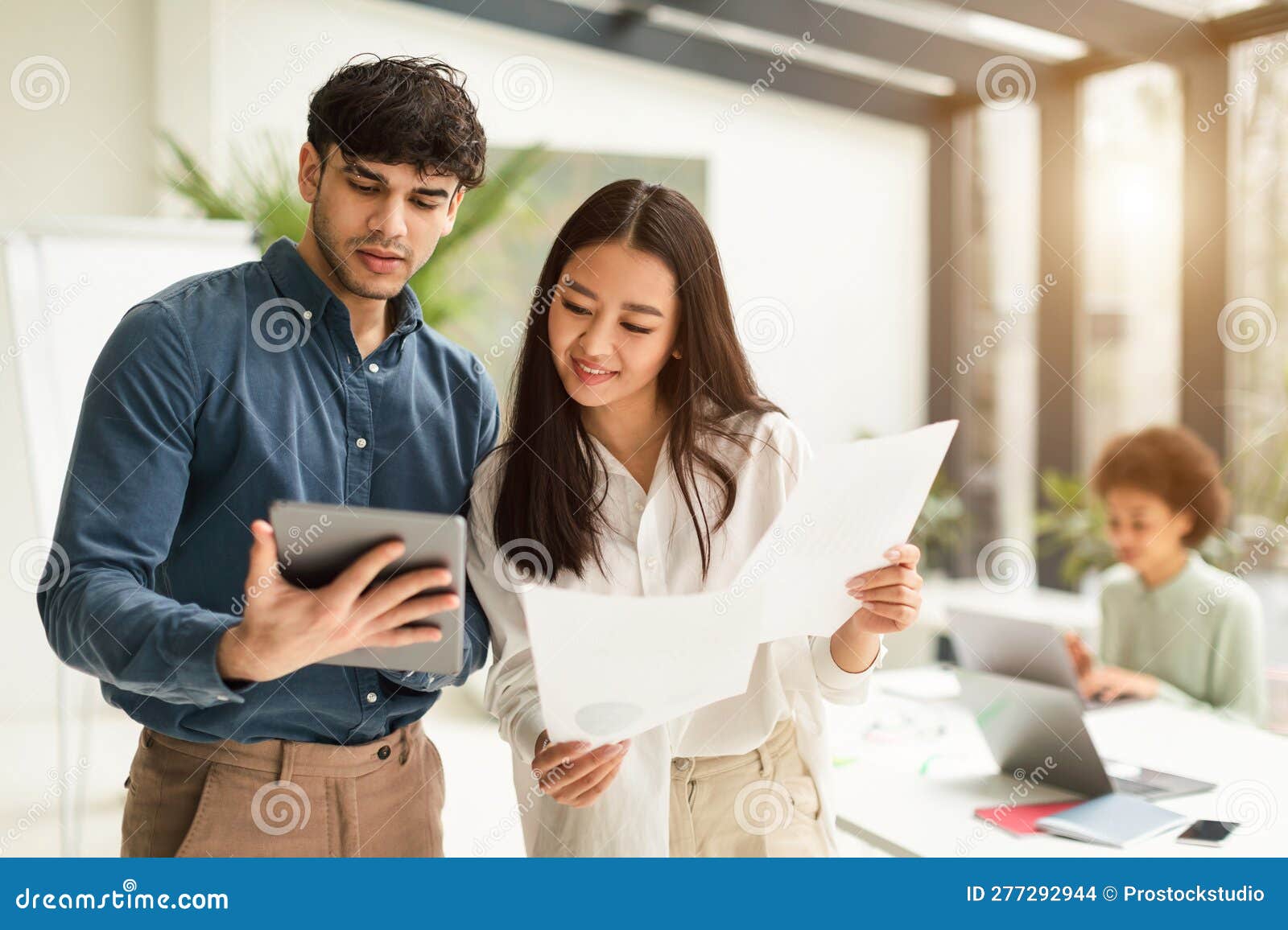 Two Diverse Business People Using Tablet Interacting Working in Office ...