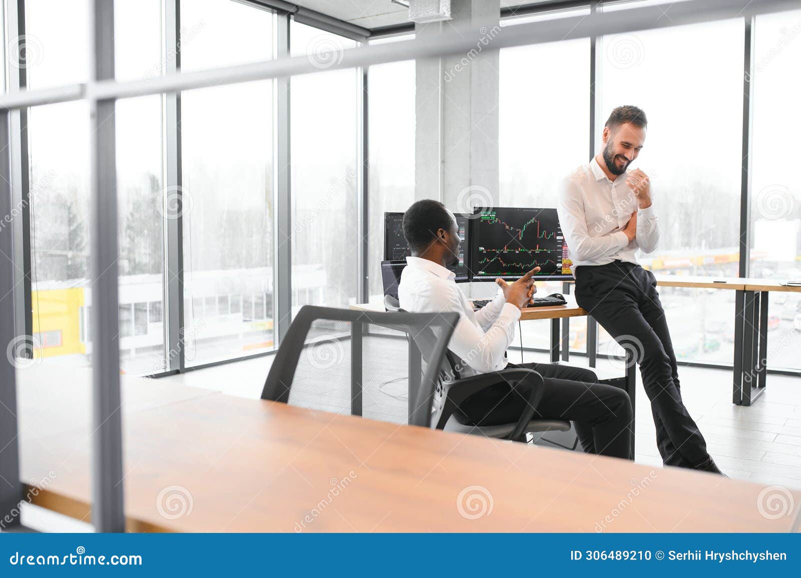 Two Diverse Colleagues Traders Talking To Each Other, Sitting in the ...