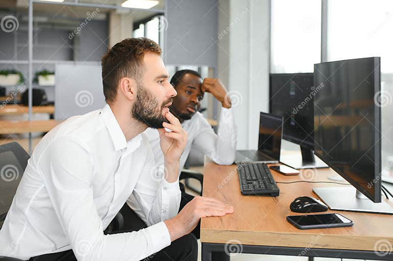 Two Diverse Colleagues Traders Talking To Each Other, Sitting in the ...