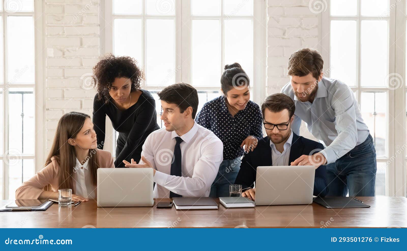 Two Diverse Group of Colleagues Meeting at Laptops, Using Computers ...