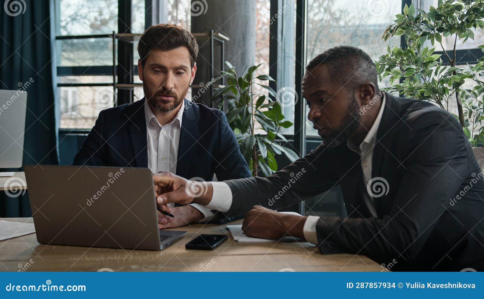 Two Diverse Multiracial Businessmen Discuss Online Data Project with ...