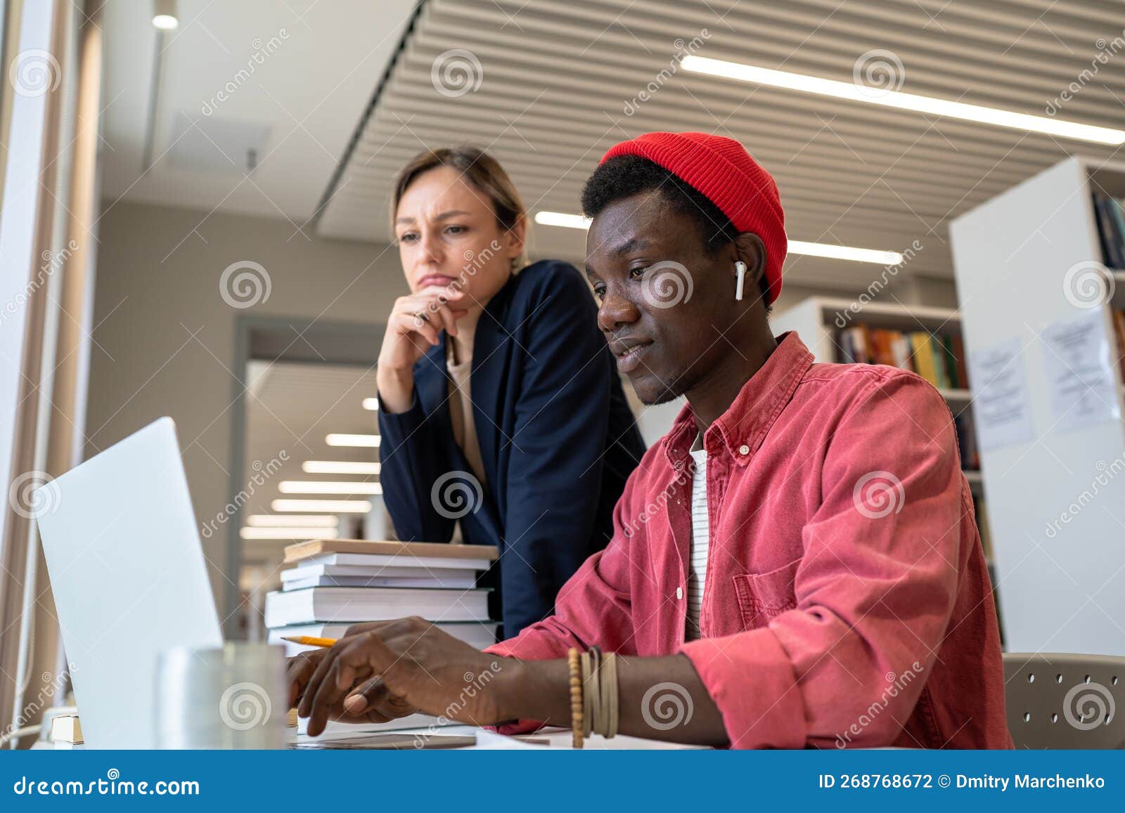 Two Diverse Students Study Partners Learning Together in Library, Using ...