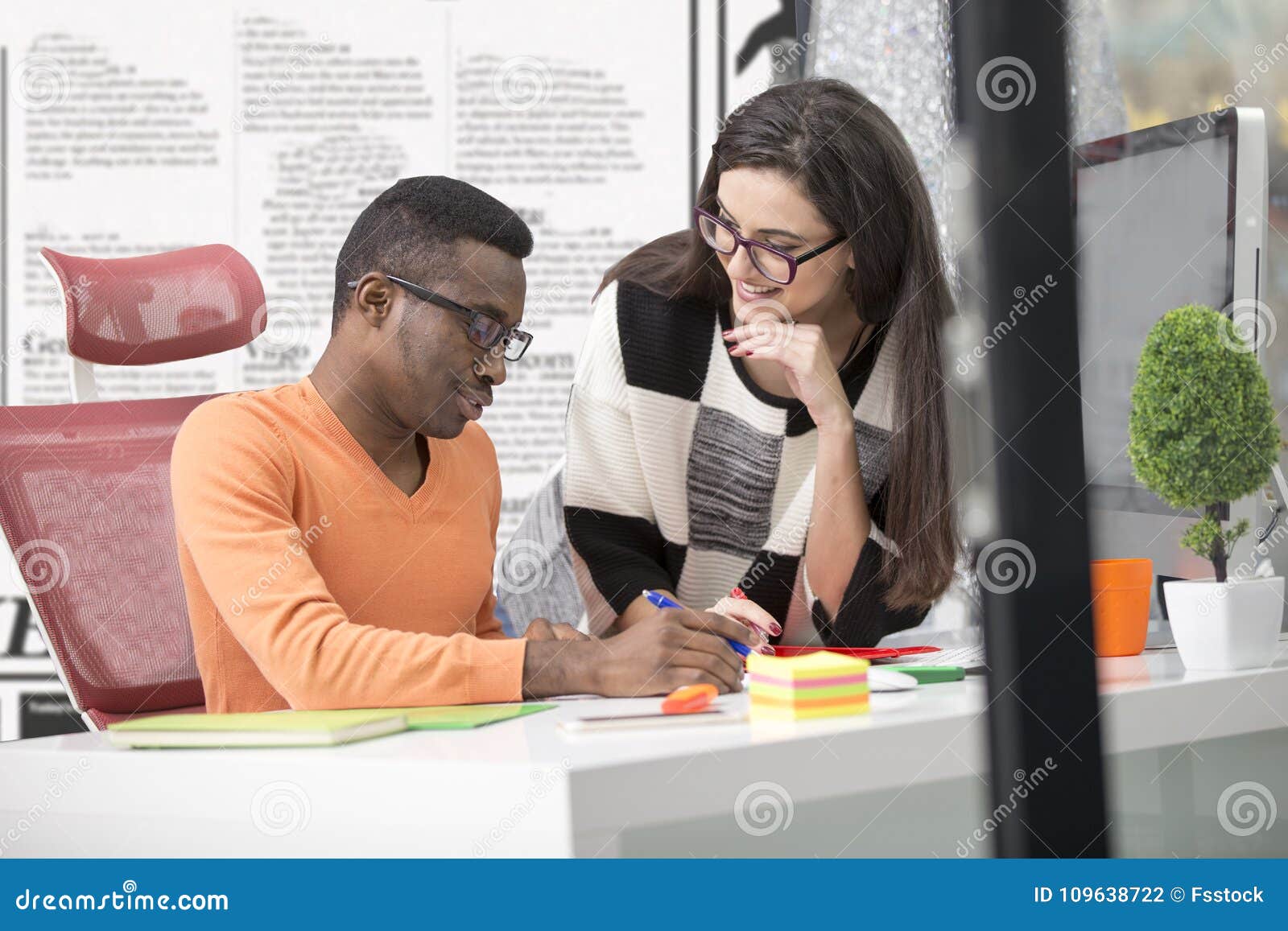 Two Diverse Work Colleagues Smiling and Writing Down Notes while ...