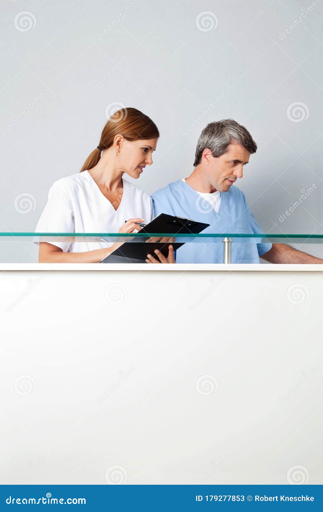 Two Doctors Behind the Counter Stock Image - Image of clinic, disposal ...