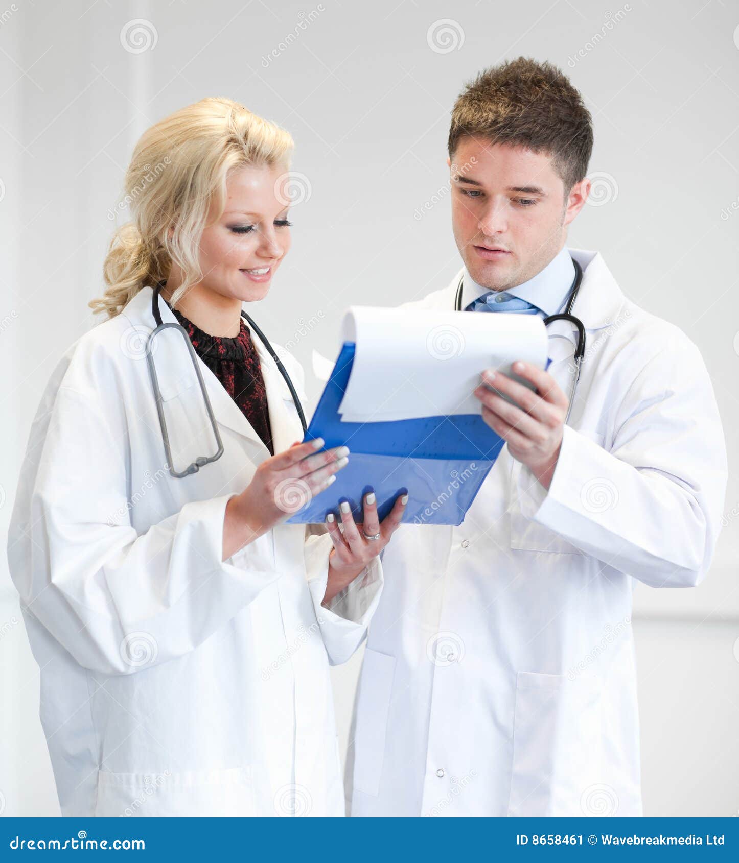 Two Doctors with a Clipboard Stock Image - Image of scrubs, isolated ...