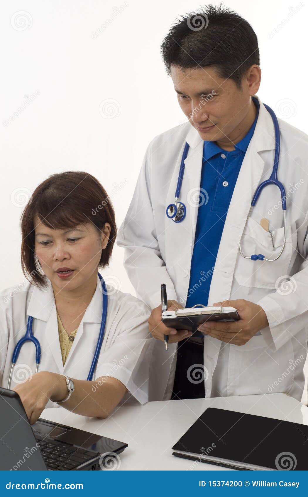 Two Doctors consulting stock photo. Image of office, sittting - 15374200