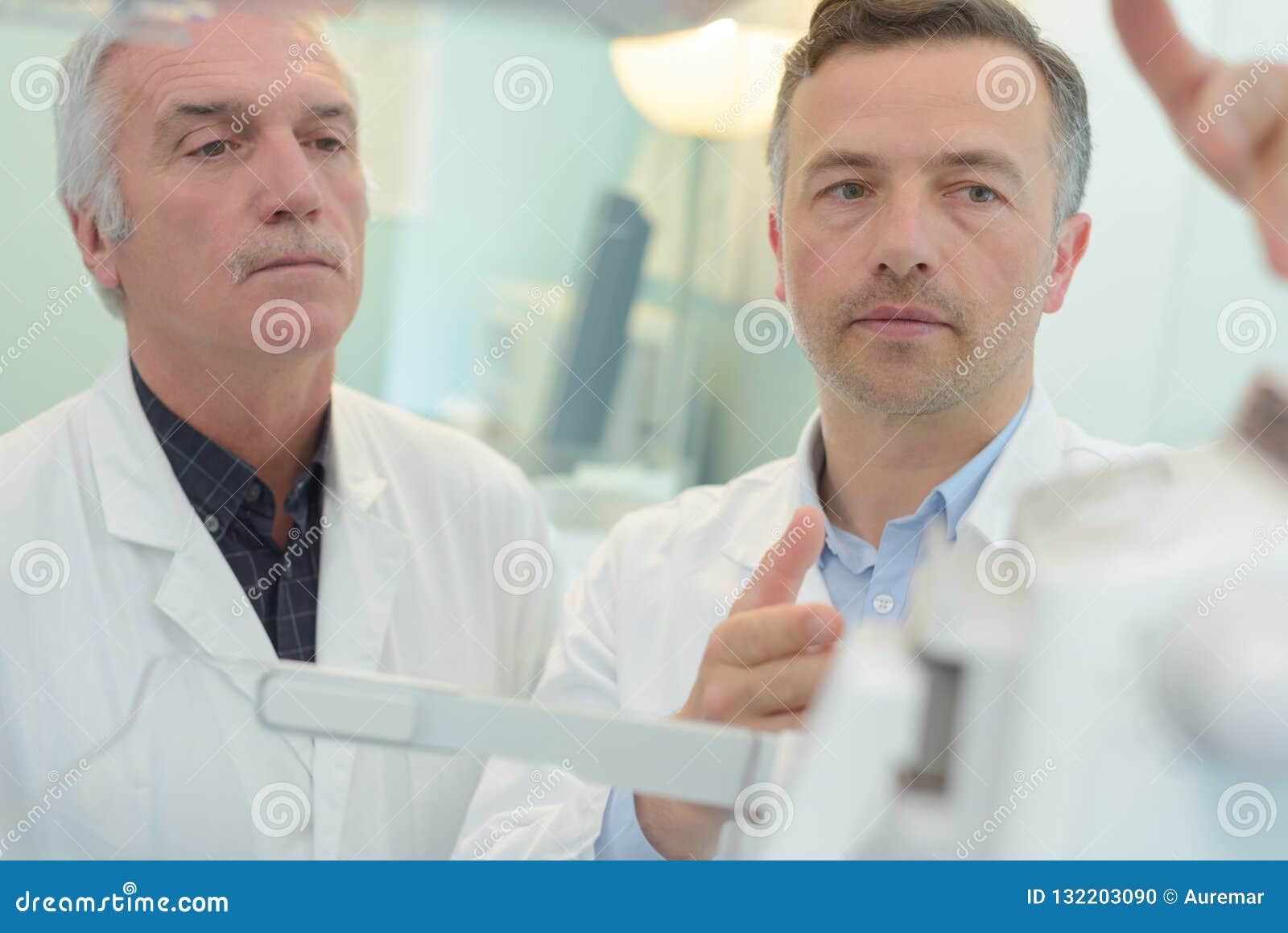 Two Doctors Consulting Each Other about Patients Diagnosis Stock Photo ...