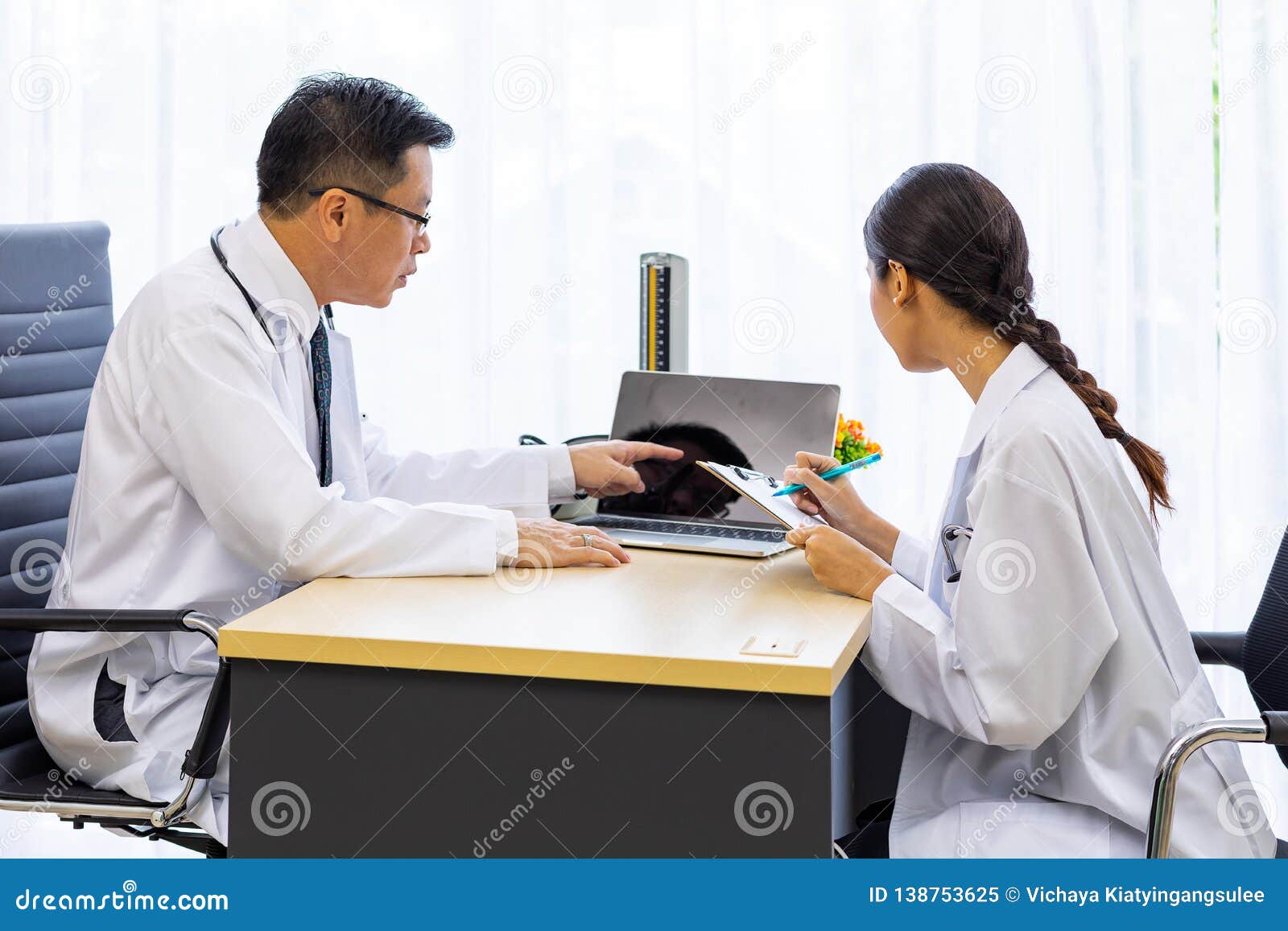 Two doctors discussing stock image. Image of office - 138753625