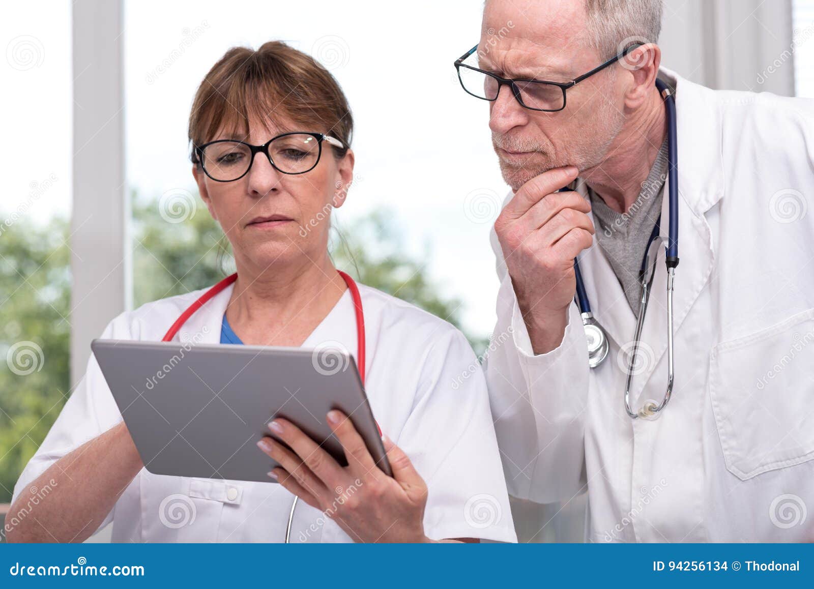 Two Doctors Discussing about Medical Report on Tablet Stock Photo ...