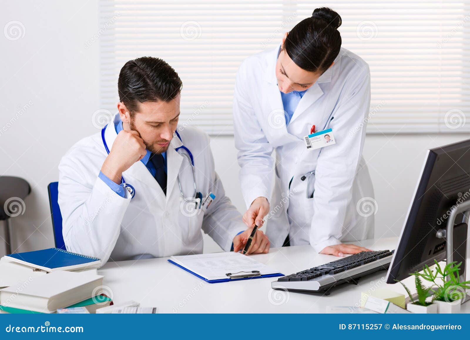 Two Doctors Discussing Patient Notes in an Office Stock Image - Image ...