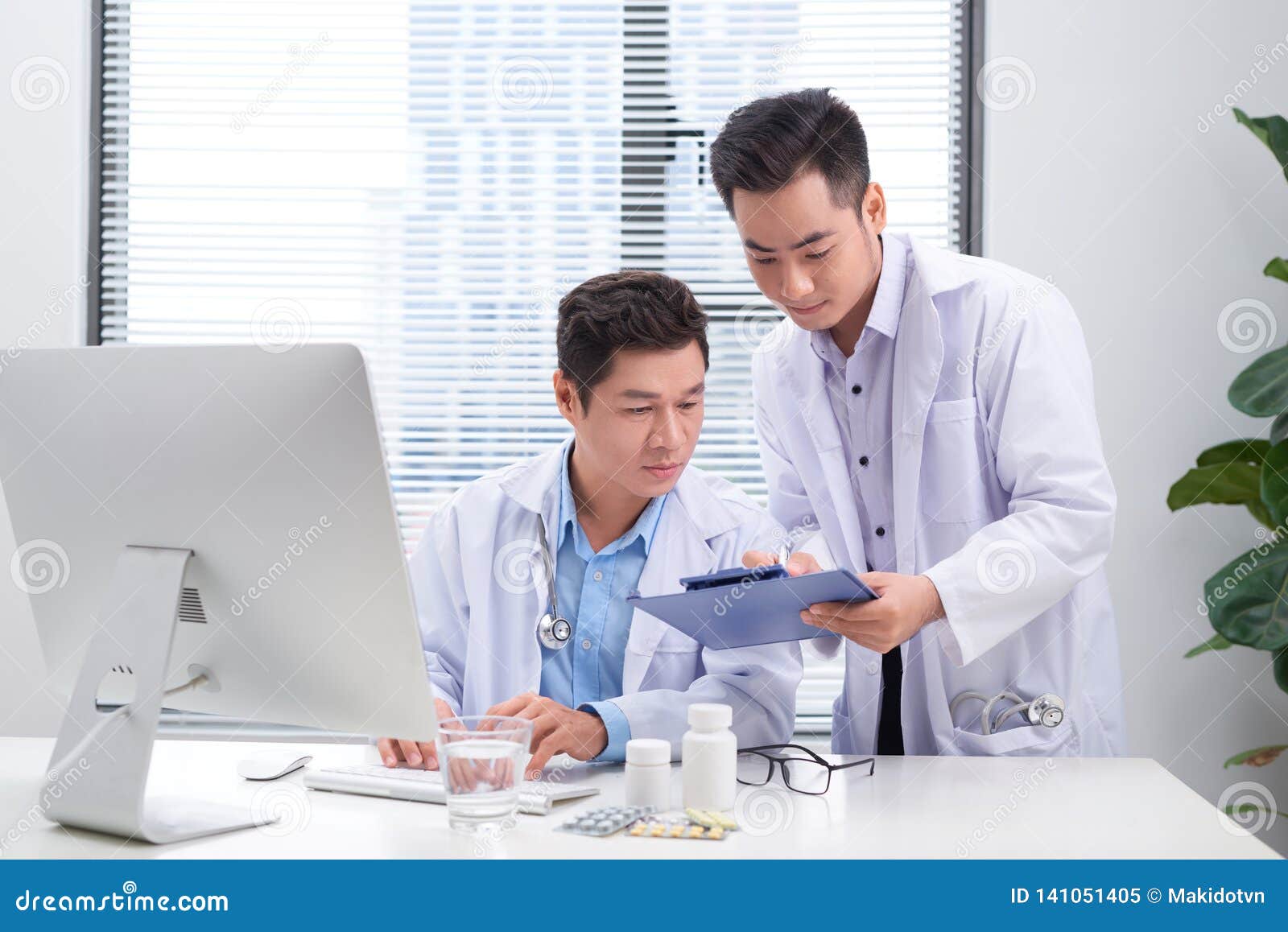 Two Doctors Discussing a Patient`s Medical Records Stock Image - Image ...