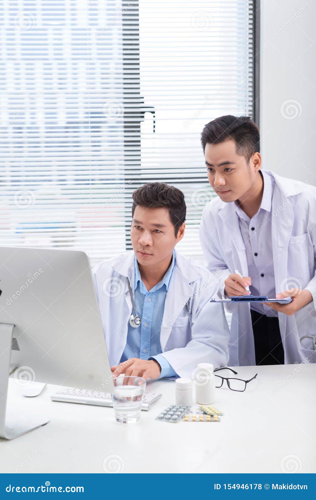 Two Doctors Discussing a Patient`s Medical Records Stock Photo - Image ...