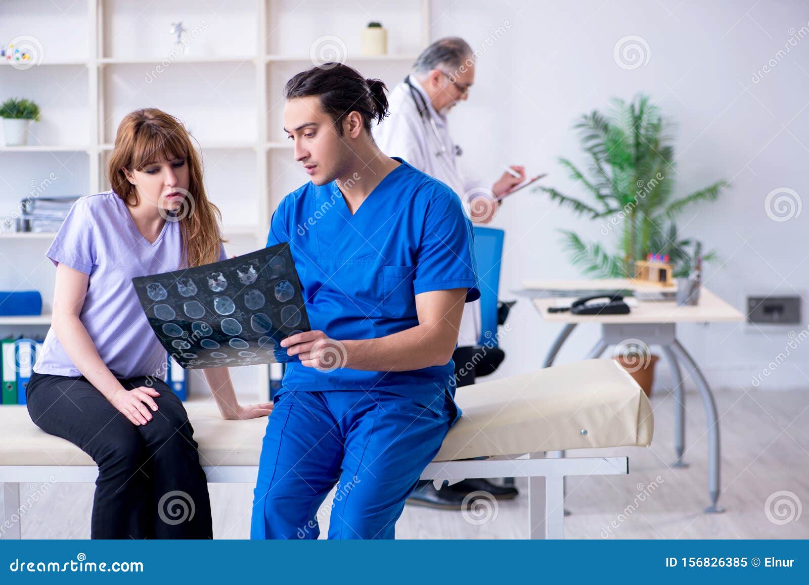 Two Doctors Examining Young Woman Stock Image - Image of medicine ...
