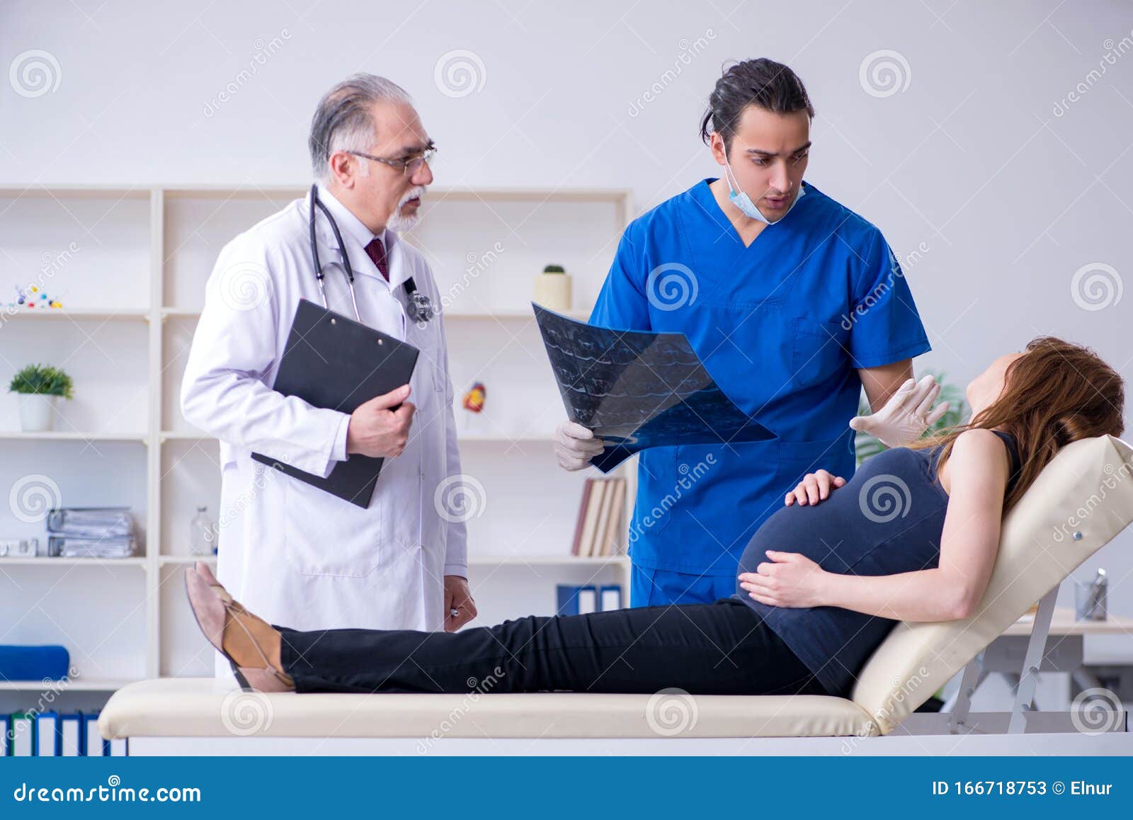 Two Doctors Examining Young Woman Stock Image - Image of patient ...