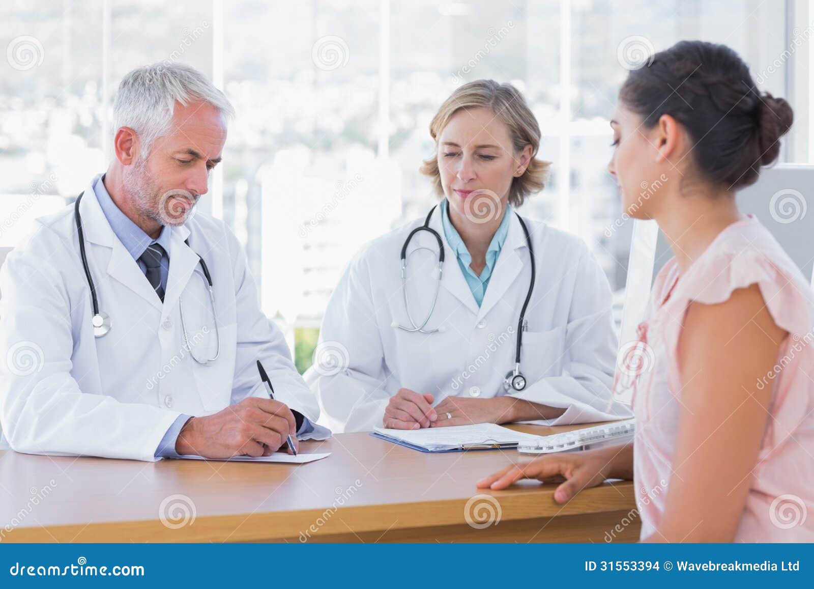 Two Doctors with a Female Patient Stock Photo - Image of healthcare ...