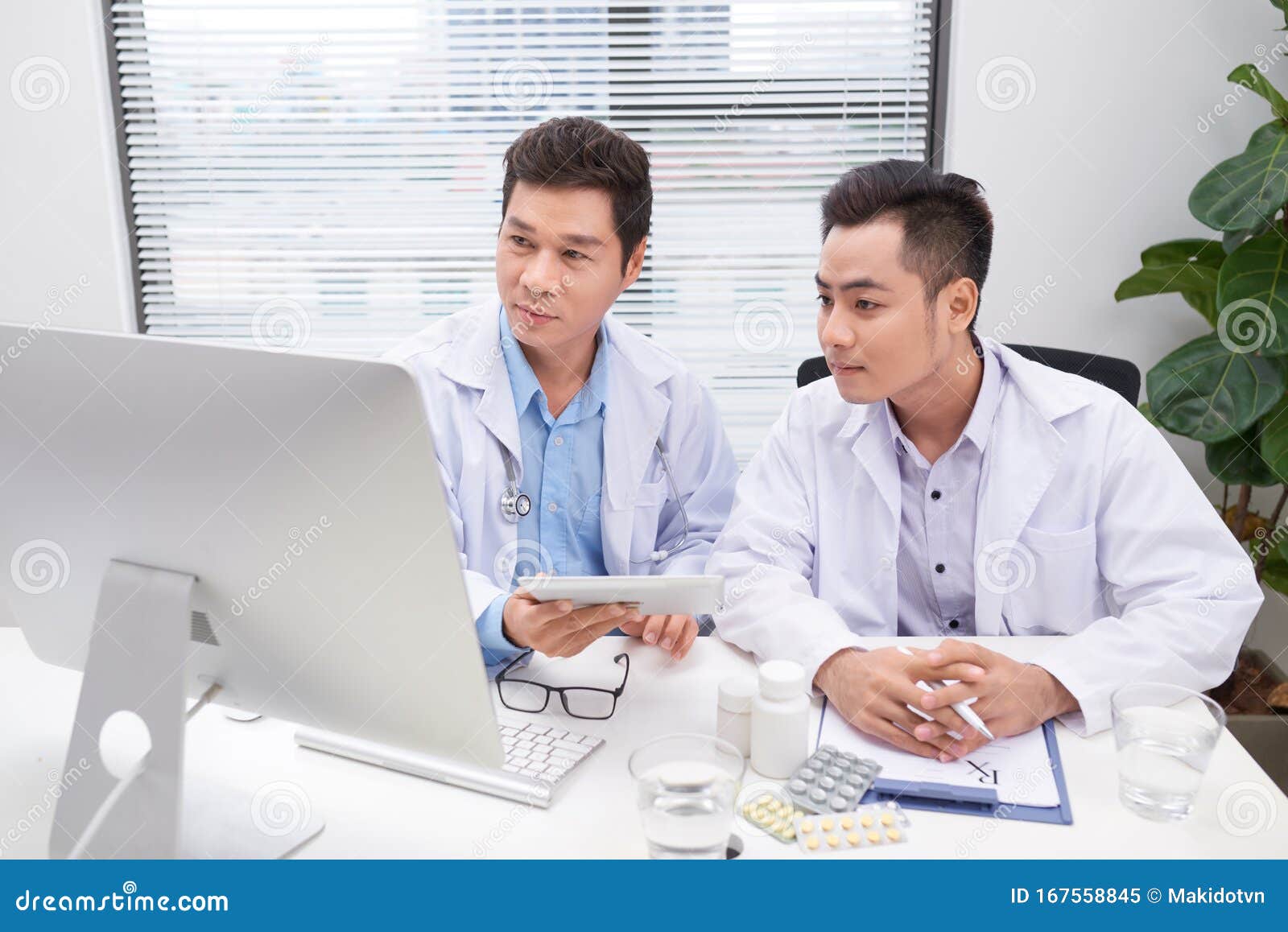 Two Doctors Holding and Talking about Patient on Office Stock Image ...