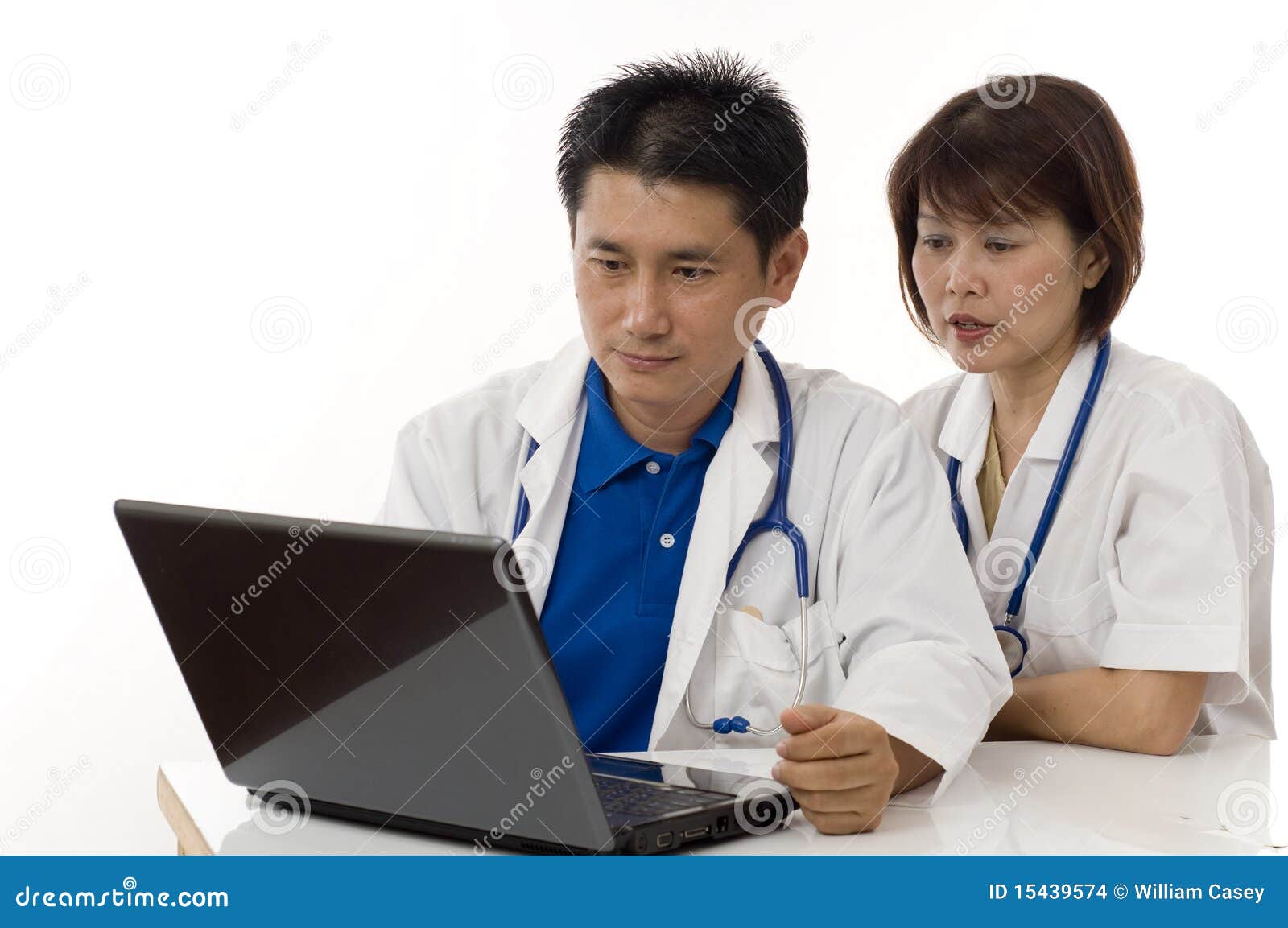 Two Doctors Looking at Computer on Their Desk Stock Photo - Image of ...