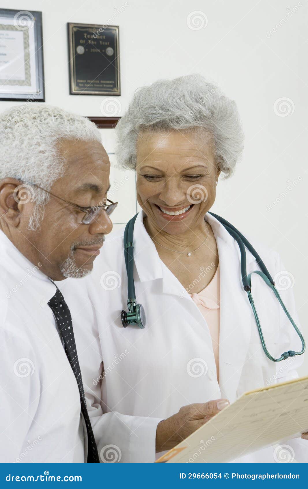 Two Doctors Looking at a Document in Clinic Stock Photo - Image of ...