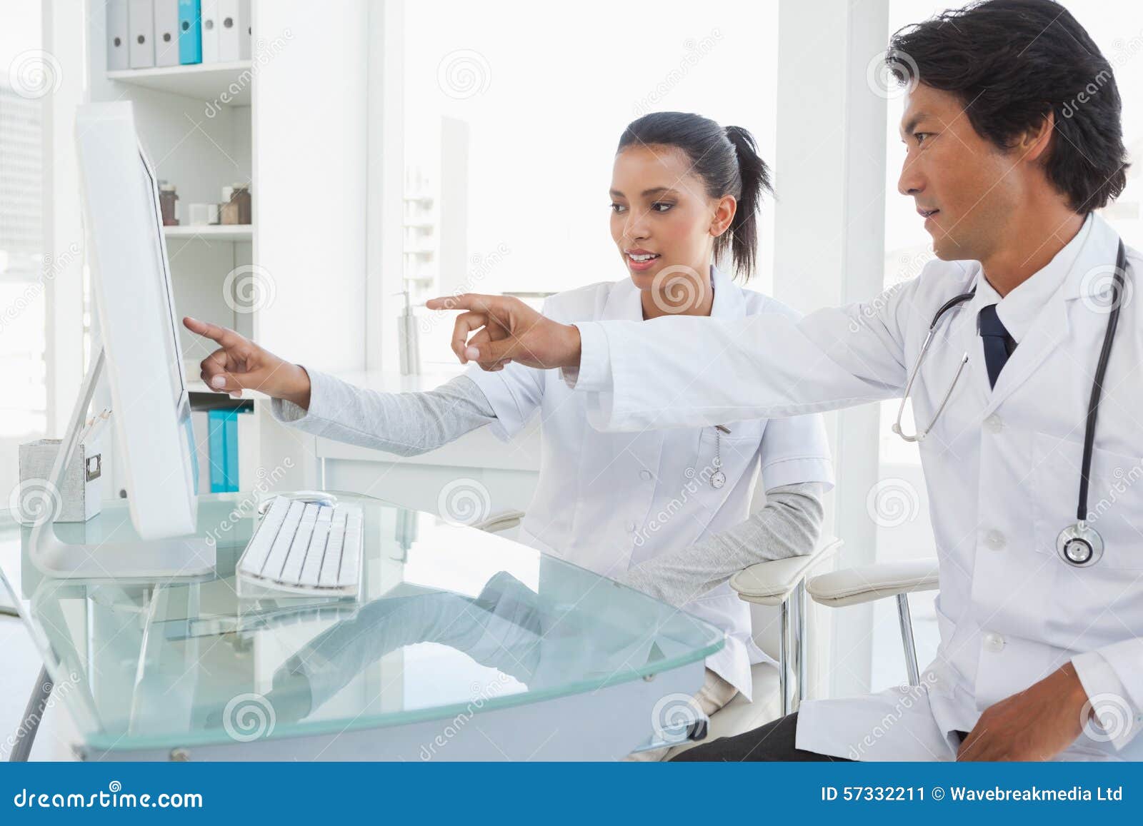 Two Doctors Pointing To Computer Screen Stock Image - Image of people ...