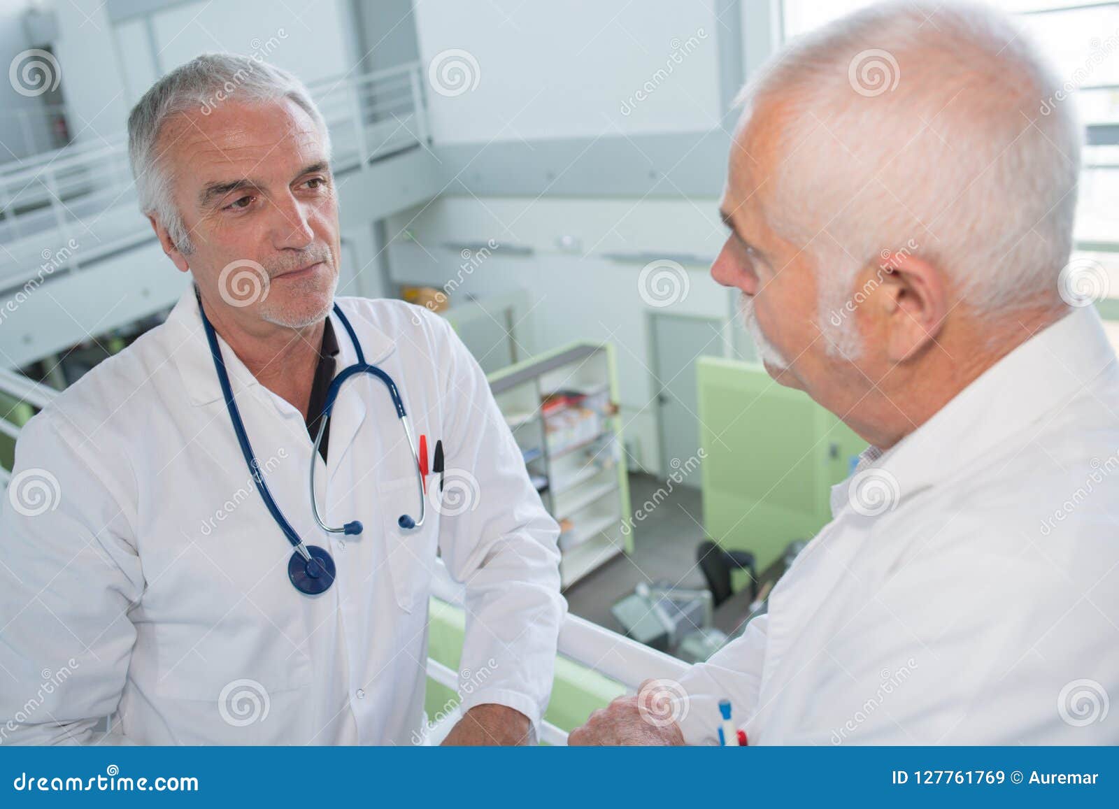 Two Doctors Talking As they Walk through Modern Hospital Stock Image ...