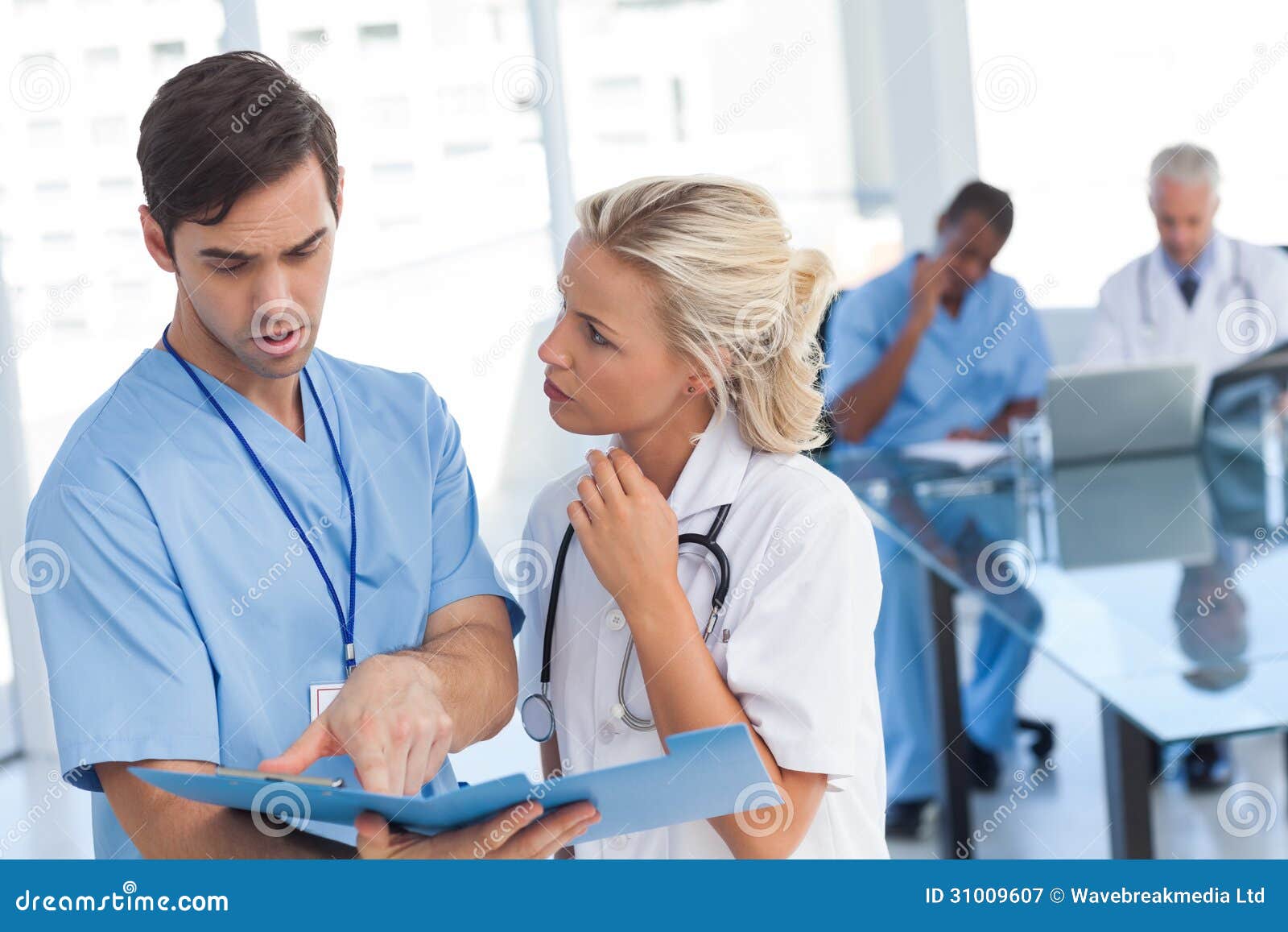 Two Doctors Talking about a Blue File Stock Image - Image of doctor ...