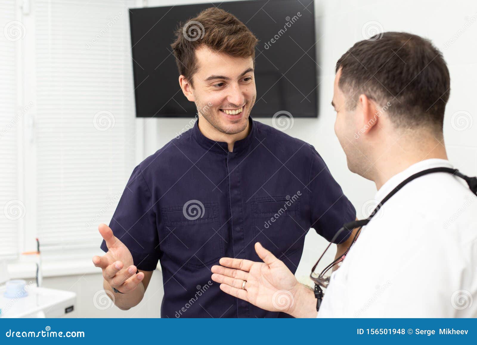 Two Doctors Talking with Each Other in Hospital Stock Photo - Image of ...