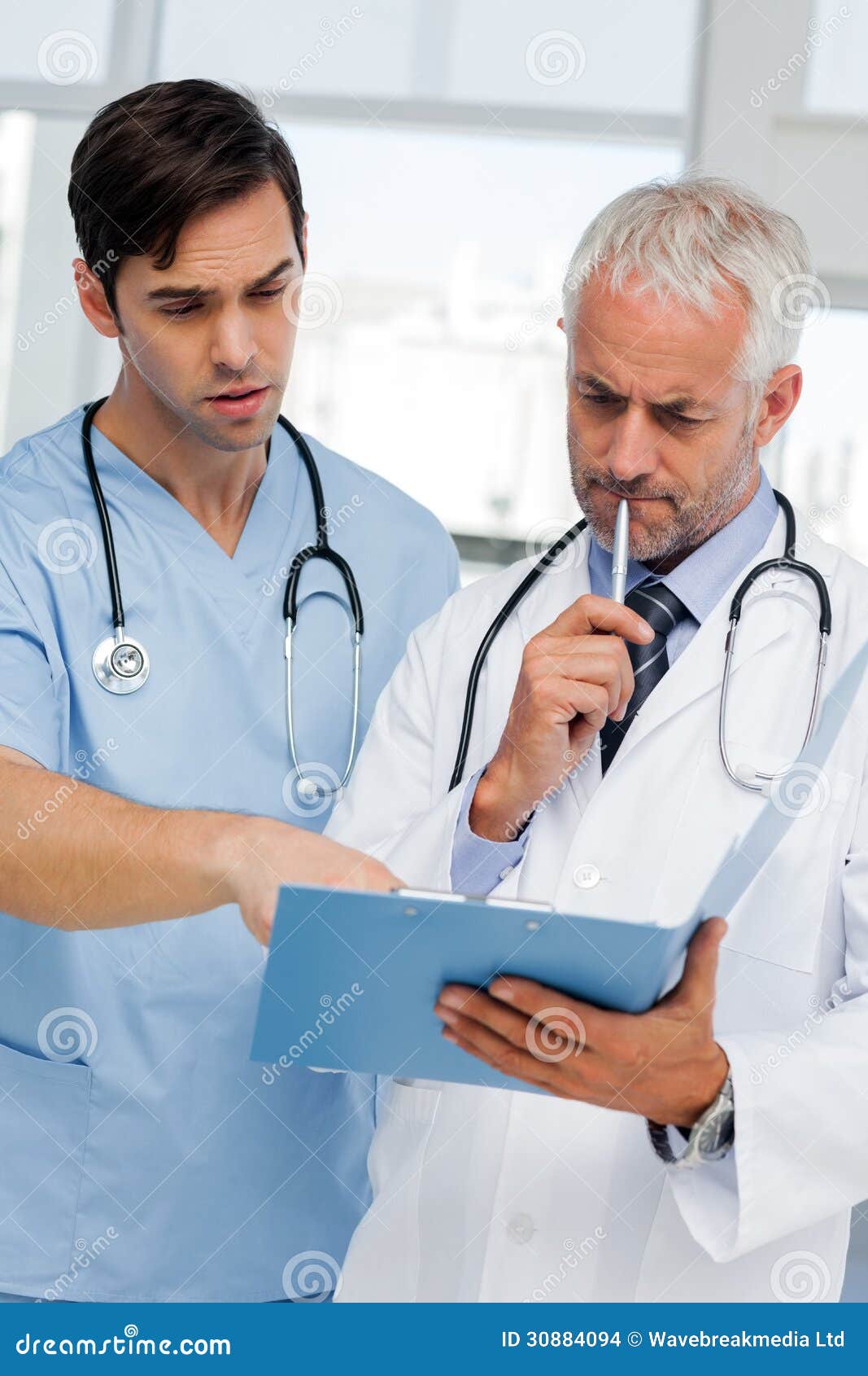 Two Doctors Talking about a File Stock Photo - Image of stethoscope ...