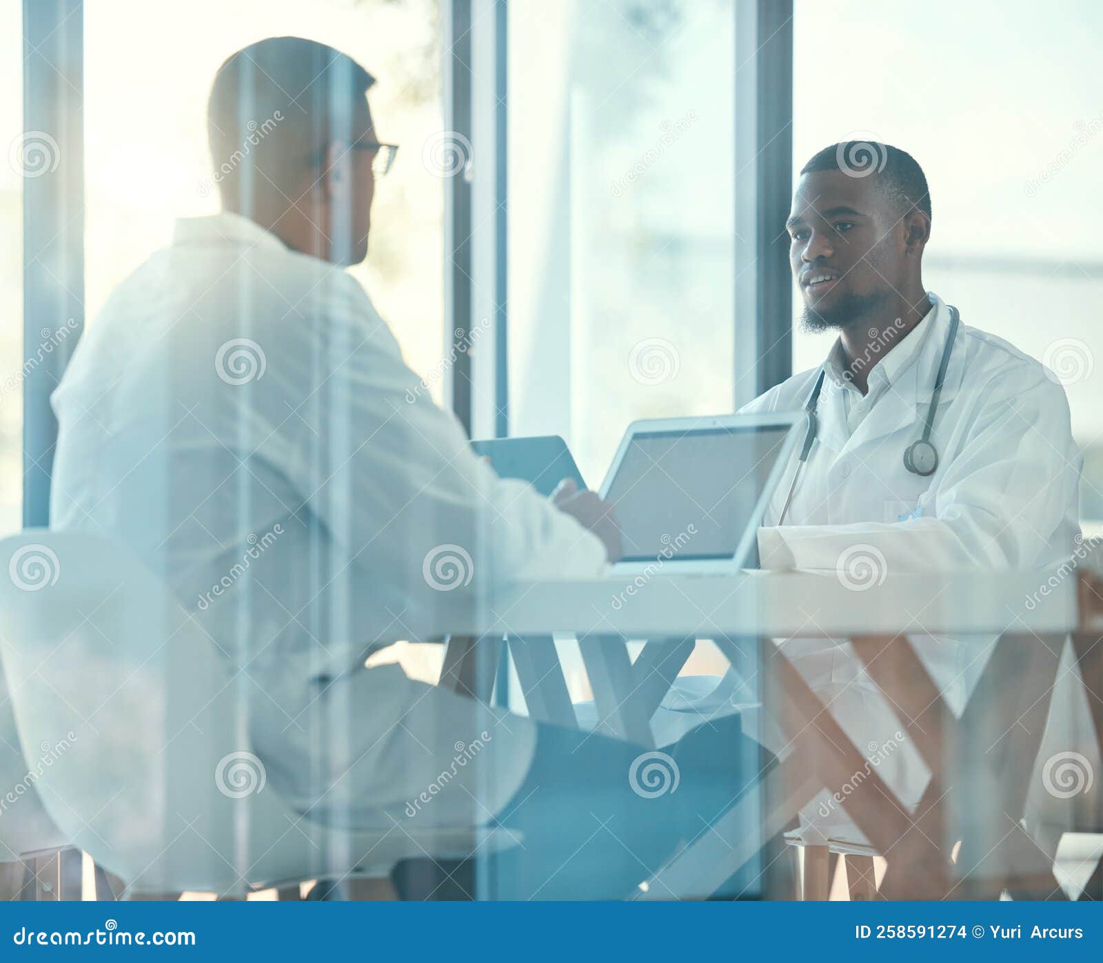 Two Doctors Talking in a Meeting. Colleagues Collaborate in a Medical ... Two Doctors Talking in a Meeting. Colleagues Collaborate in a Medical ...