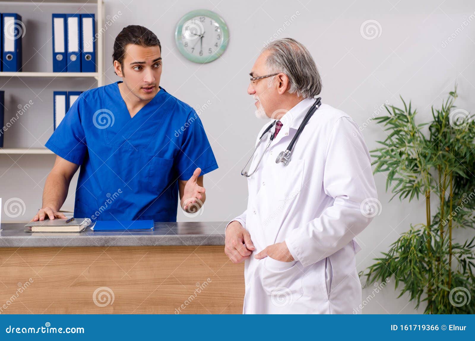 Two Doctors Talking at the Reception in Hospital Stock Photo - Image of ...