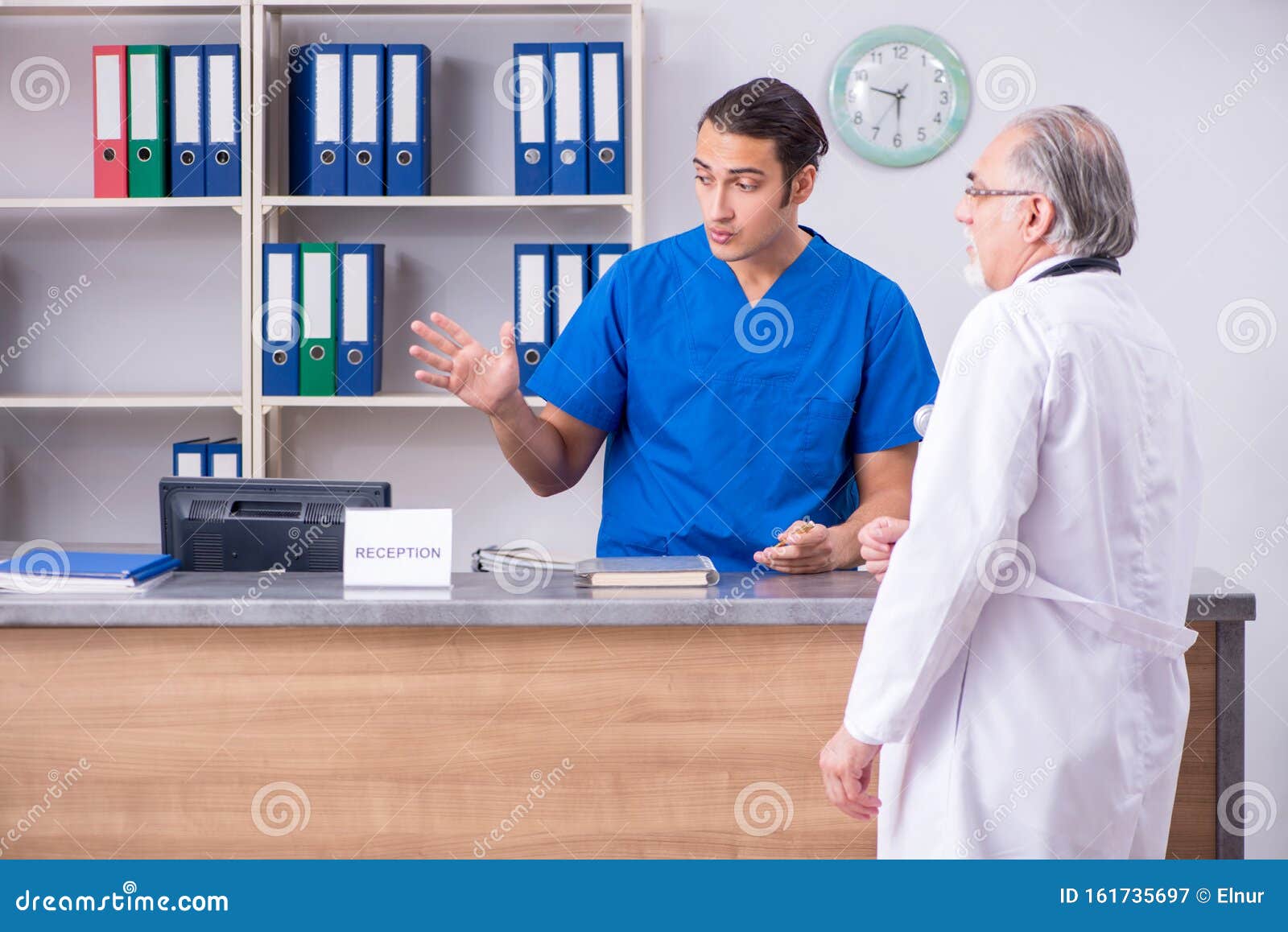 Two Doctors Talking at the Reception in Hospital Stock Image - Image of ...