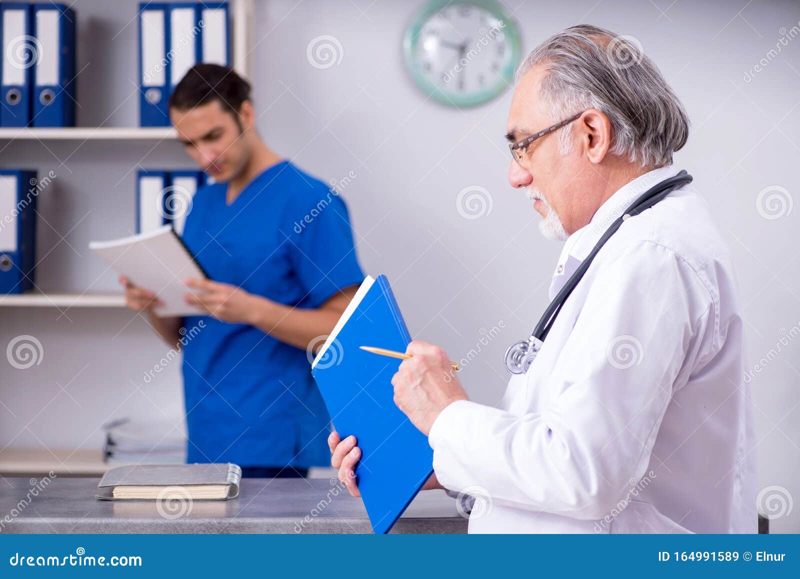 Two Doctors Talking at the Reception in Hospital Stock Image - Image of ...