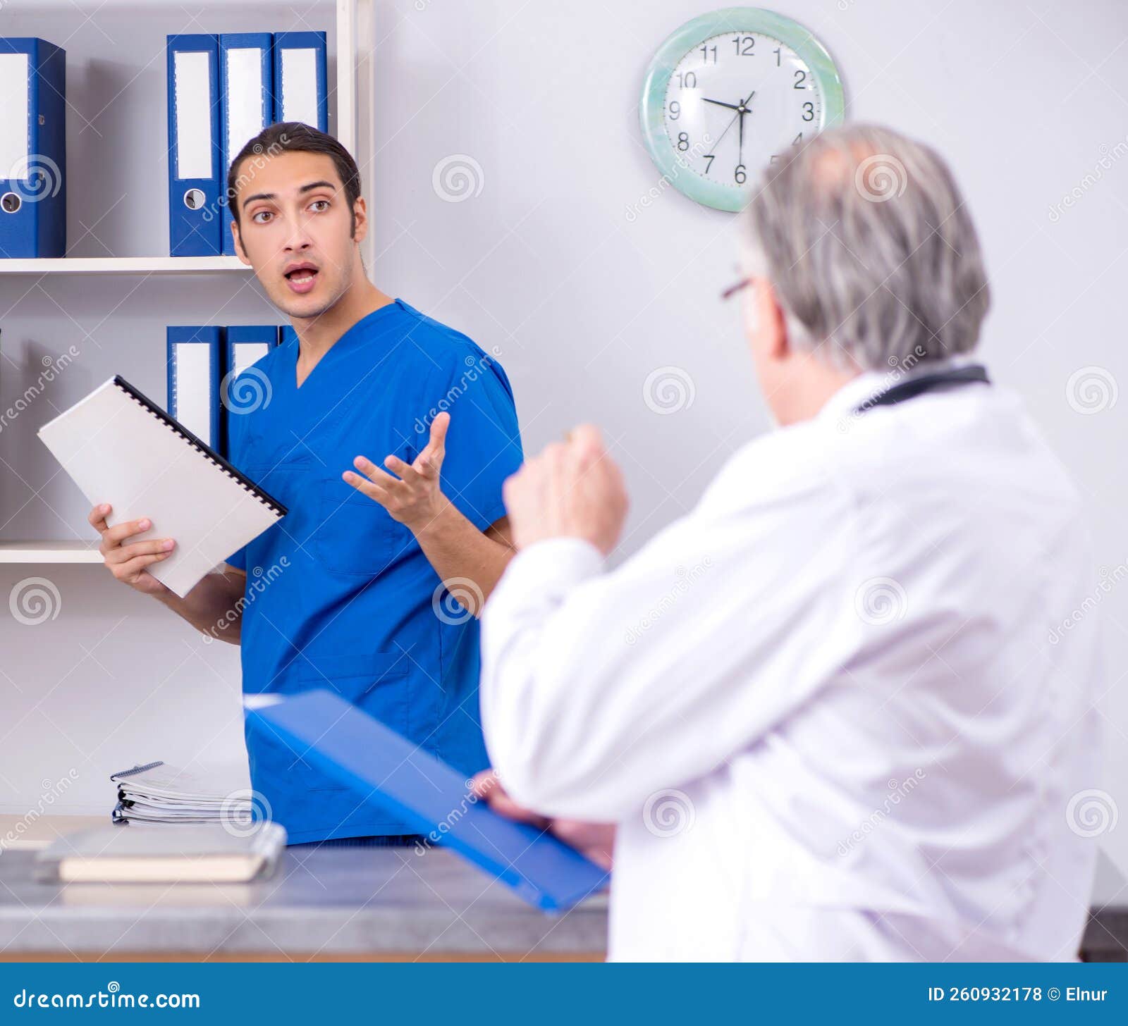 Two Doctors Talking at the Reception in Hospital Stock Photo - Image of ...