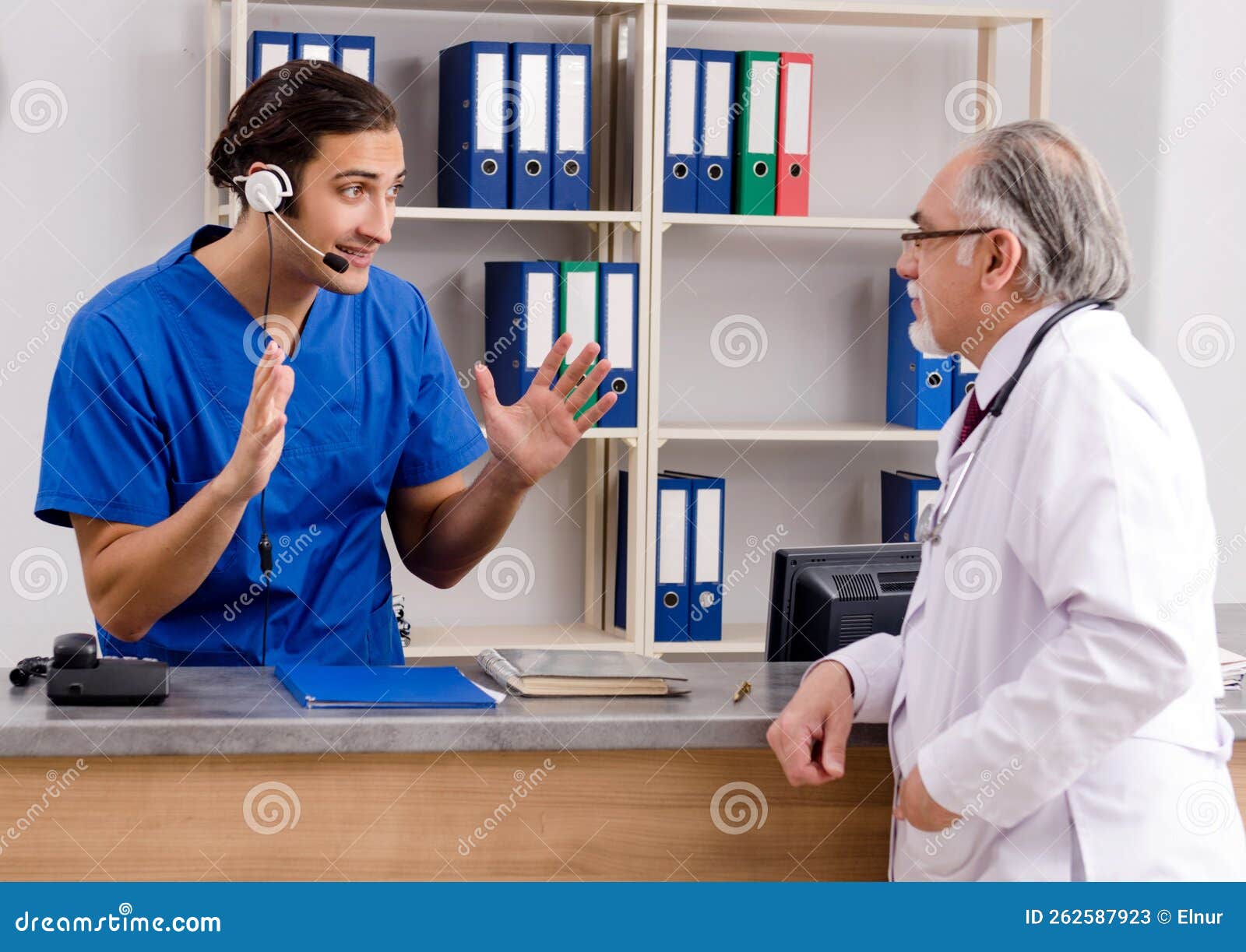 Two Doctors Talking at the Reception in Hospital Stock Image - Image of ...