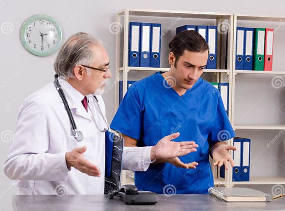 Two Doctors Talking at the Reception in Hospital Stock Photo - Image of ...