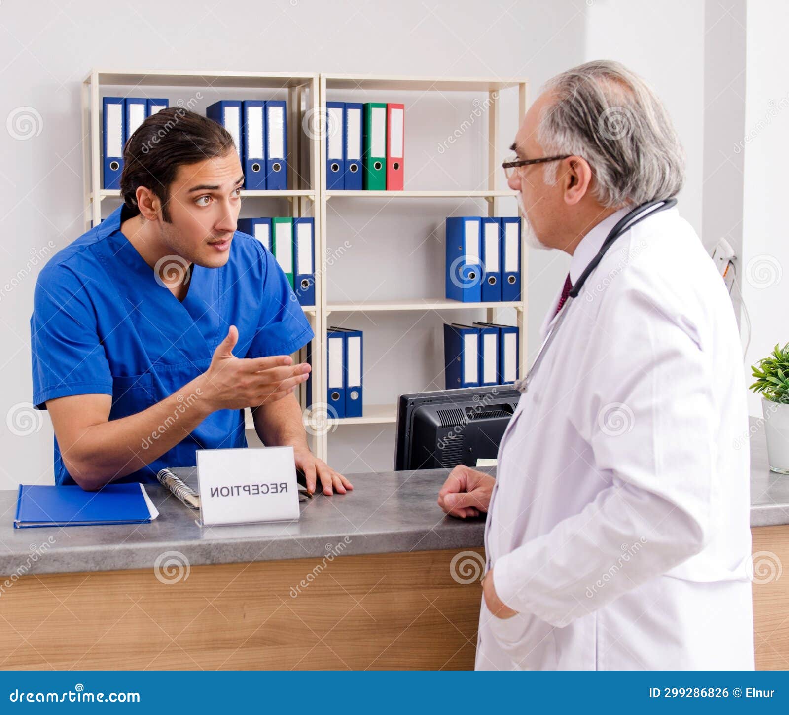 Two Doctors Talking at the Reception in Hospital Stock Photo - Image of ...
