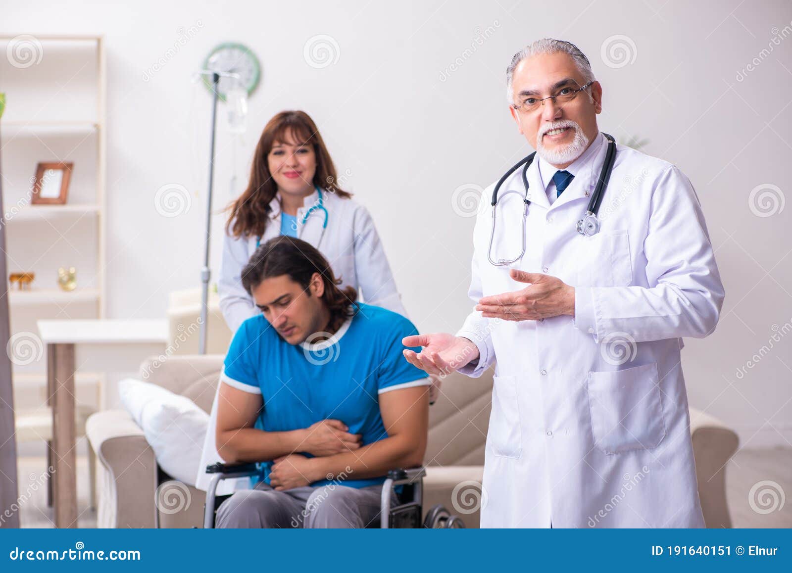 Two Doctors Visiting Sick Young Man at Home Stock Image - Image of ...