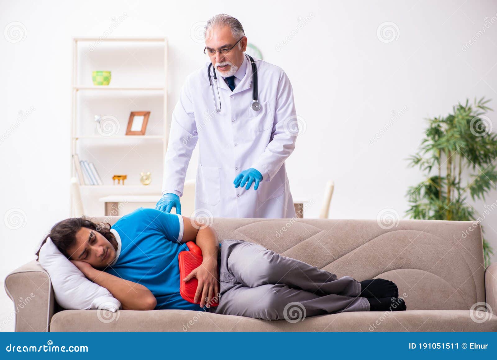 Two Doctors Visiting Sick Young Man at Home Stock Image - Image of ...