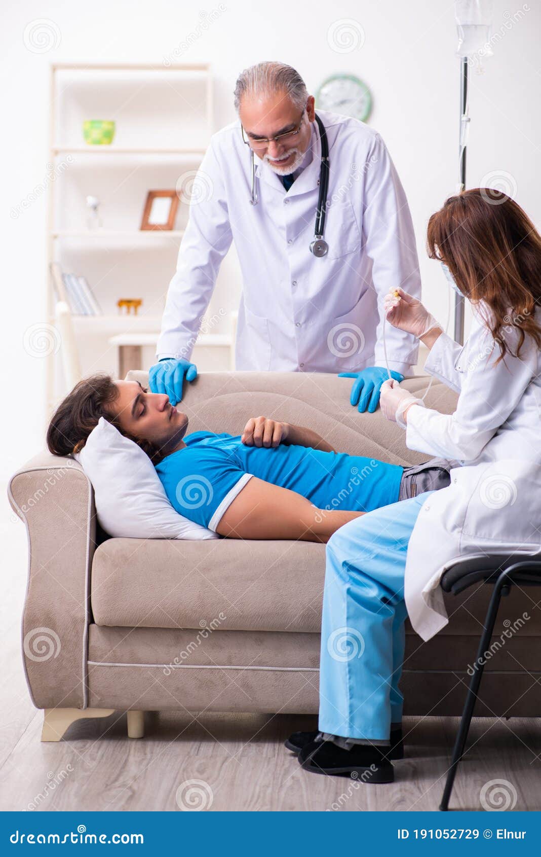 Two Doctors Visiting Sick Young Man at Home Stock Image - Image of ...