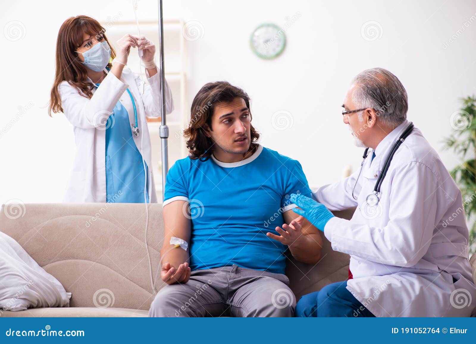 Two Doctors Visiting Sick Young Man at Home Stock Photo - Image of pole ...