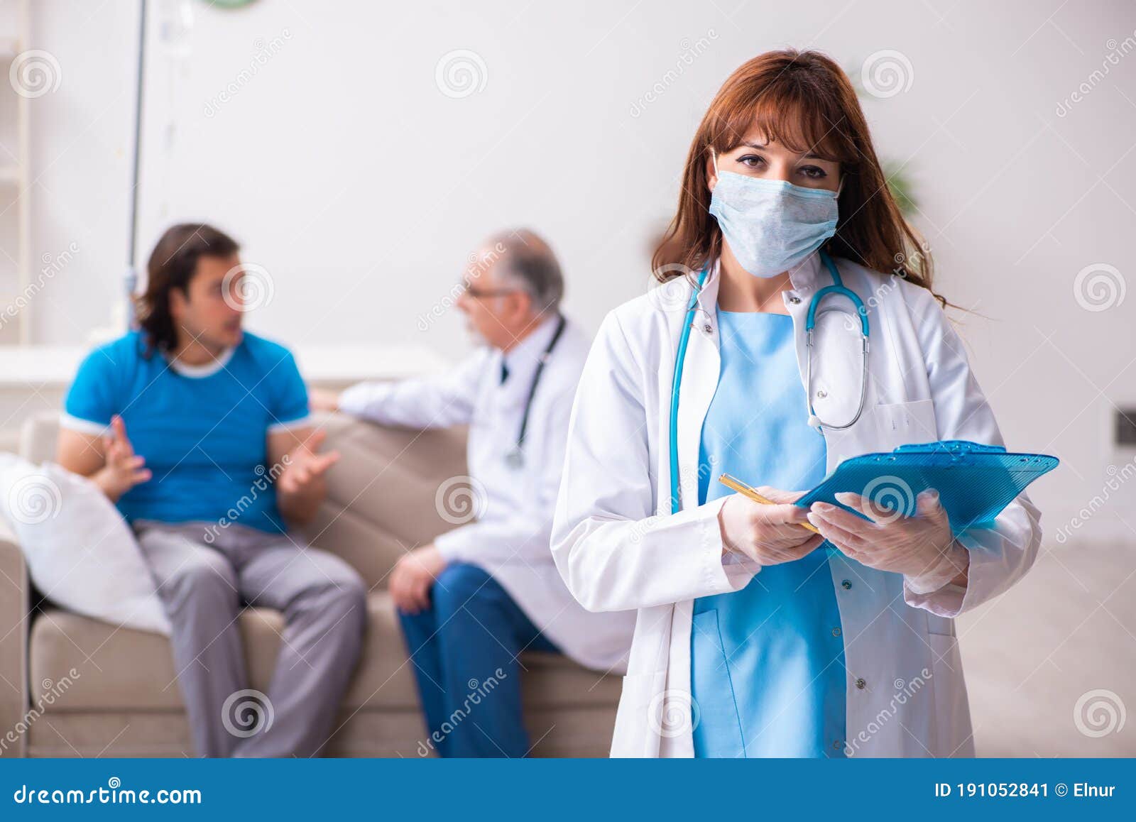 Two Doctors Visiting Sick Young Man at Home Stock Image - Image of ...