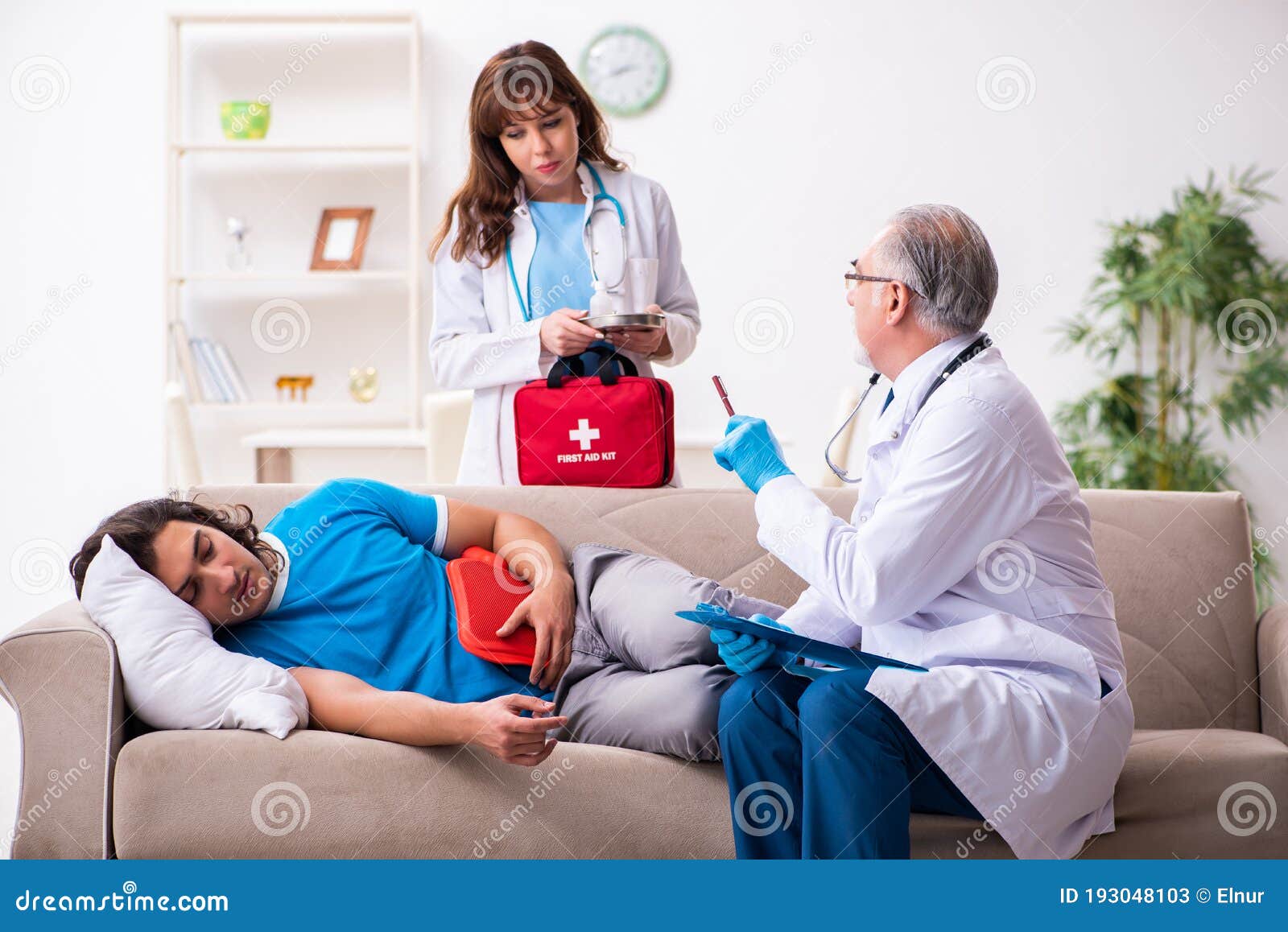 Two Doctors Visiting Sick Young Man at Home Stock Image - Image of ...
