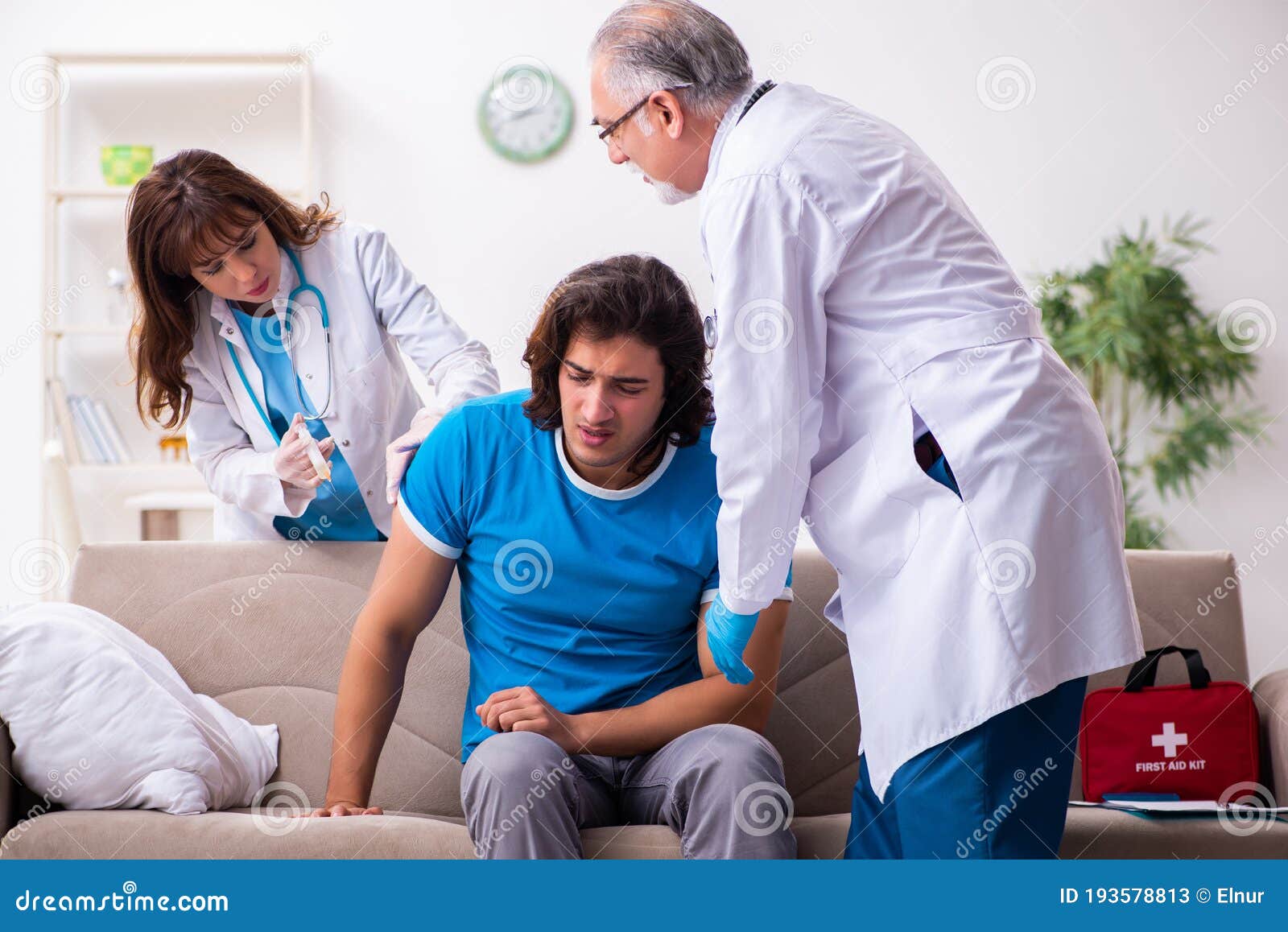 Two Doctors Visiting Sick Young Man at Home Stock Image - Image of ...